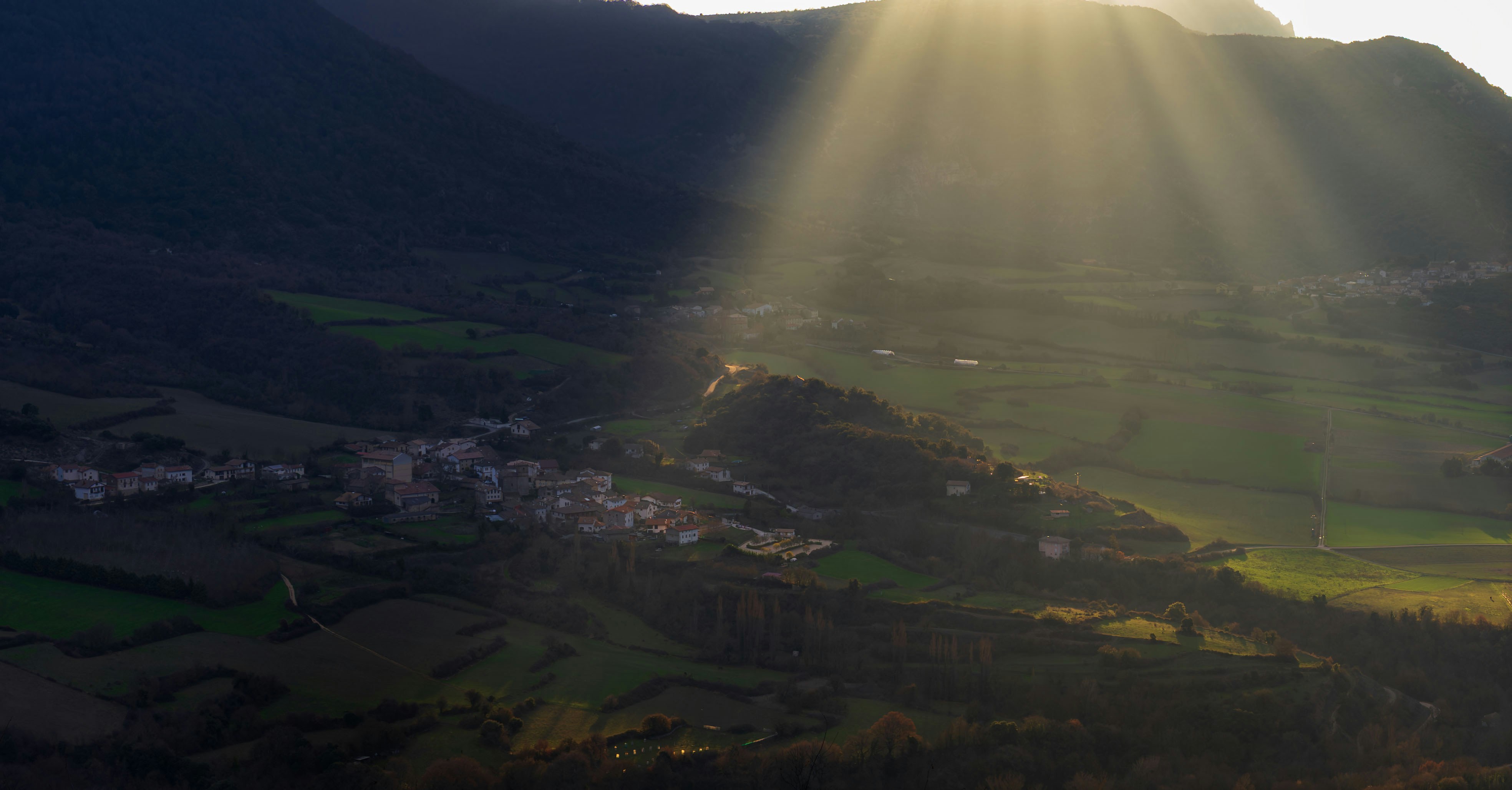 Sunbursts Over a Quiet Valley