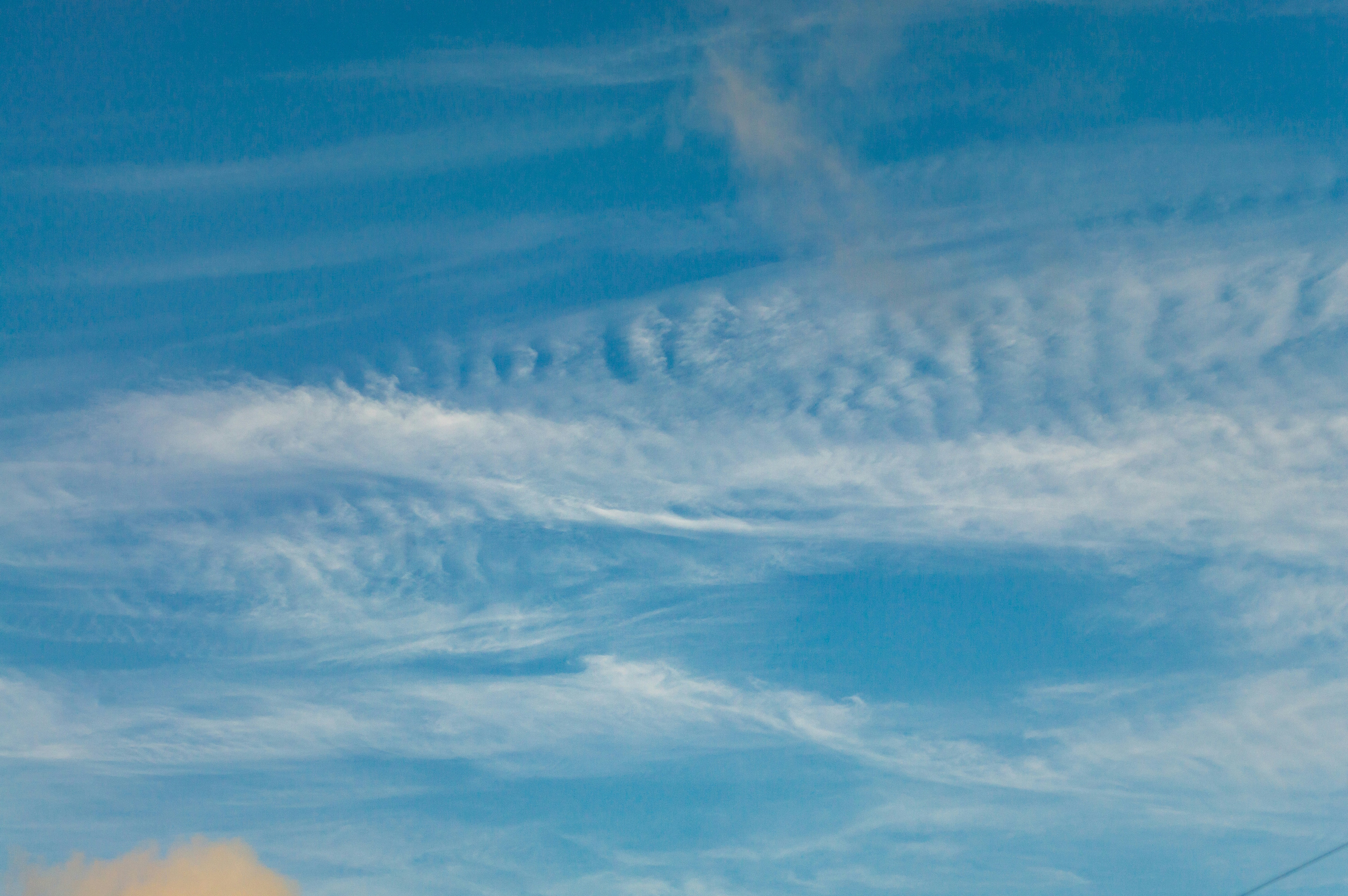 Sky Veil: Subtle Clouds Across a Calm Blue Canvas