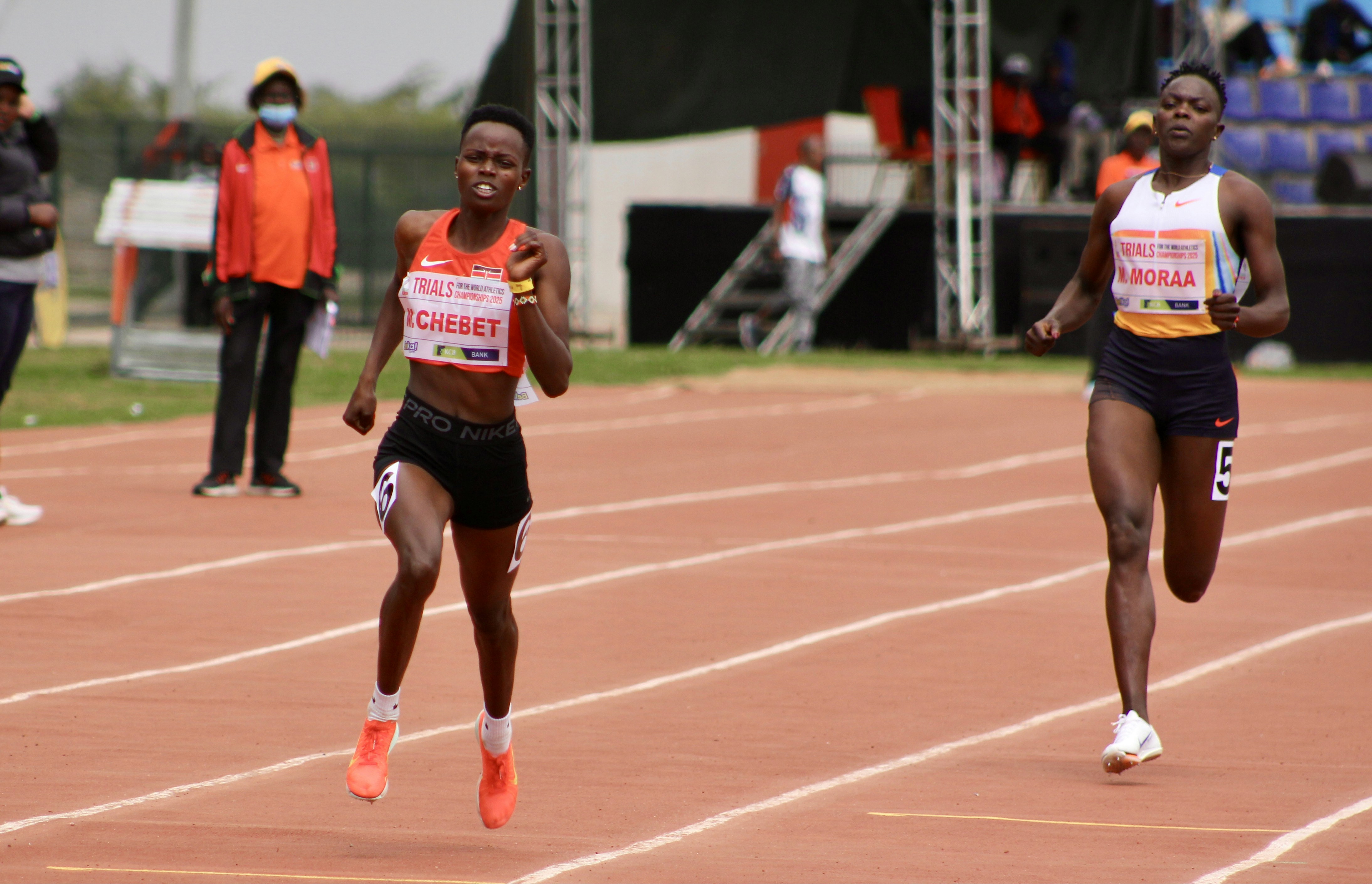 Two female athletes running a race on a track photo – Free Runner Image ...