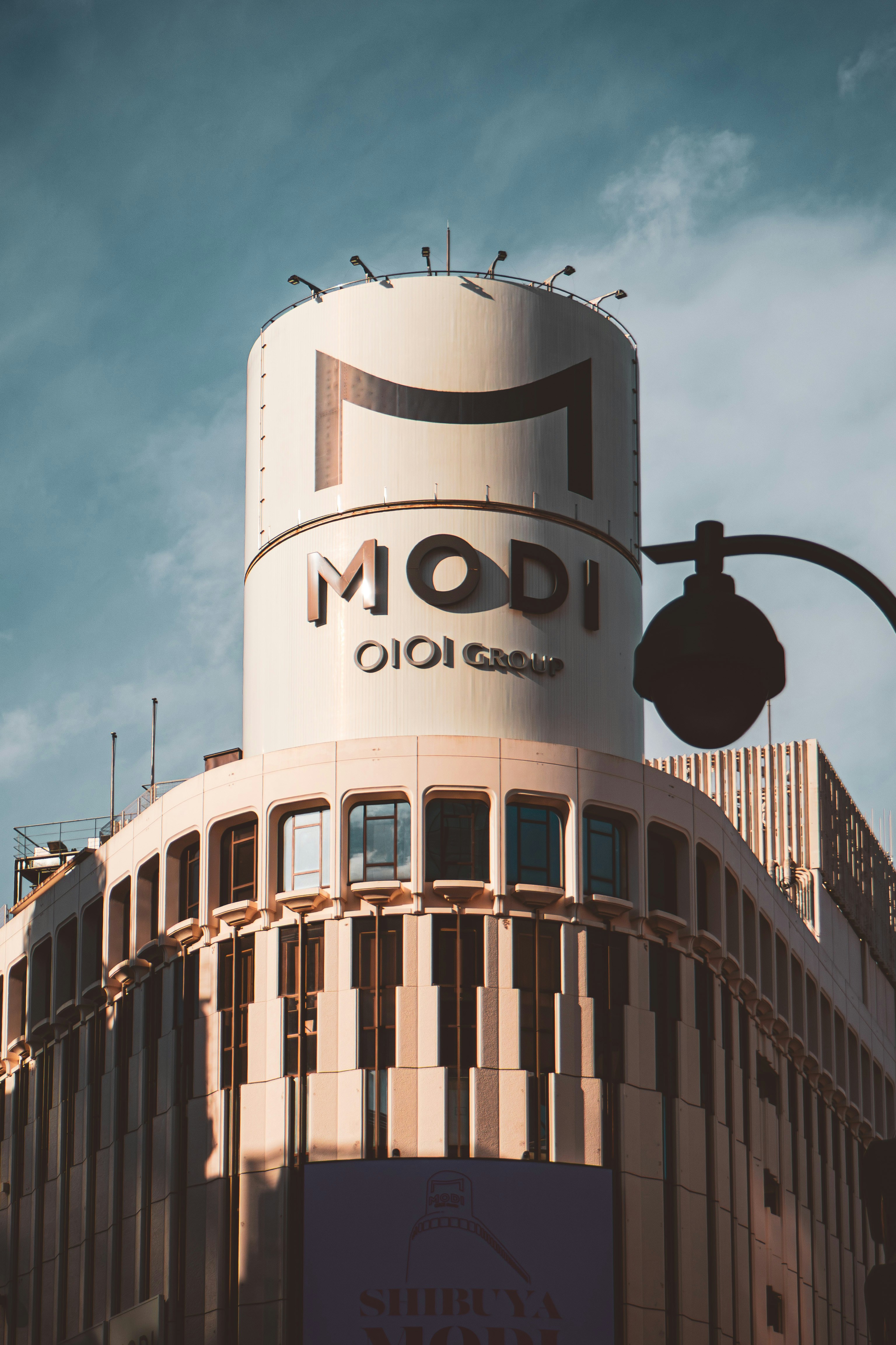 Curved Clocktower Vista: Modish Signage on a Sunlit Facade