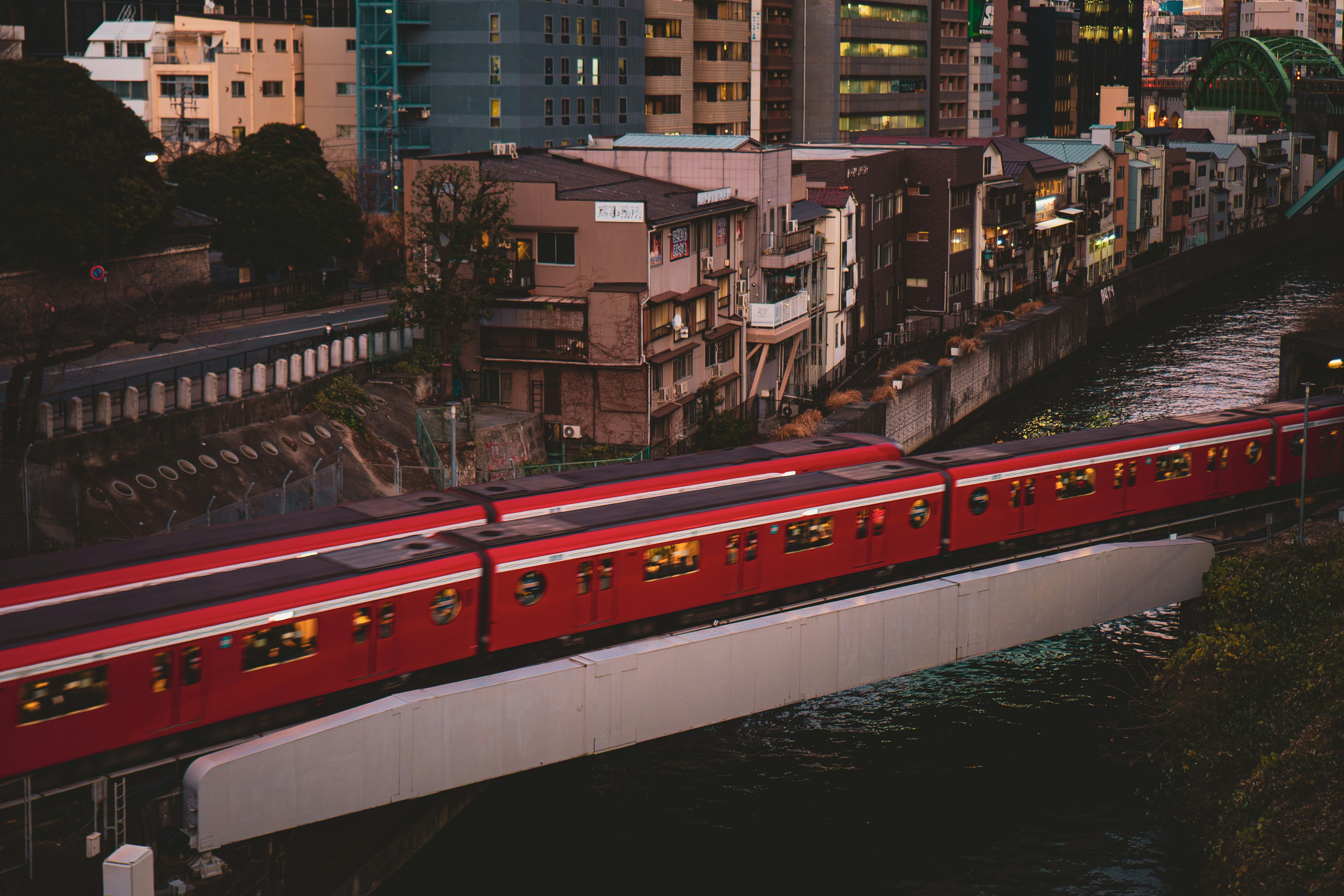 Red River Runner: A City Train Crossing at Dusk