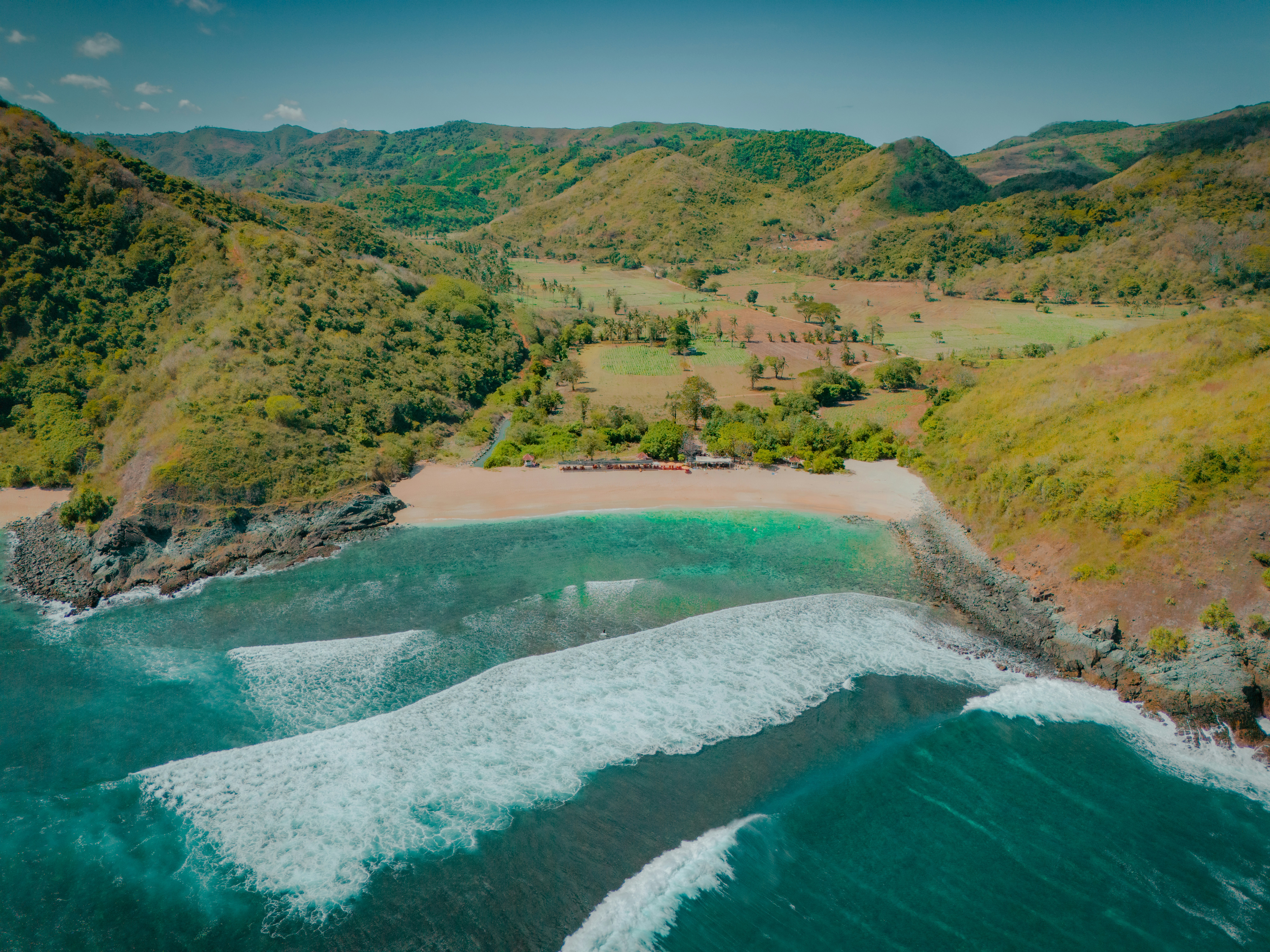 Tropical shoreline carved by turquoise tides and rolling hills