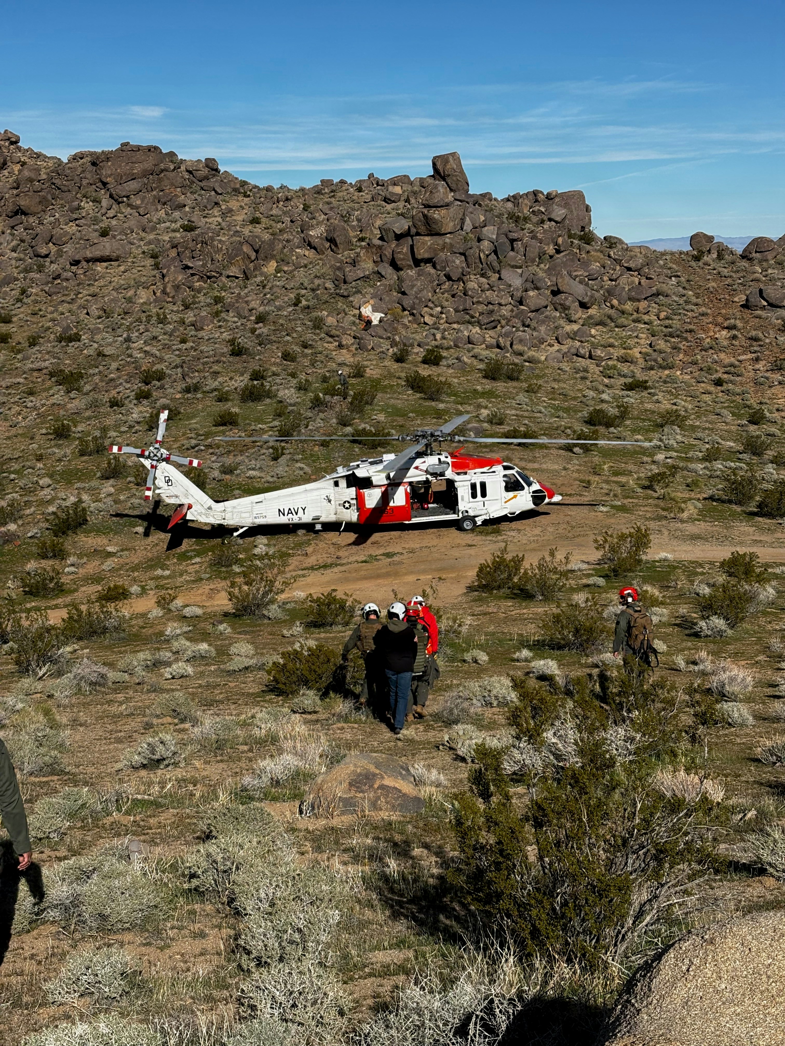  rescuerLanded in Desert: White Navy Helicopter on a rocky ridge