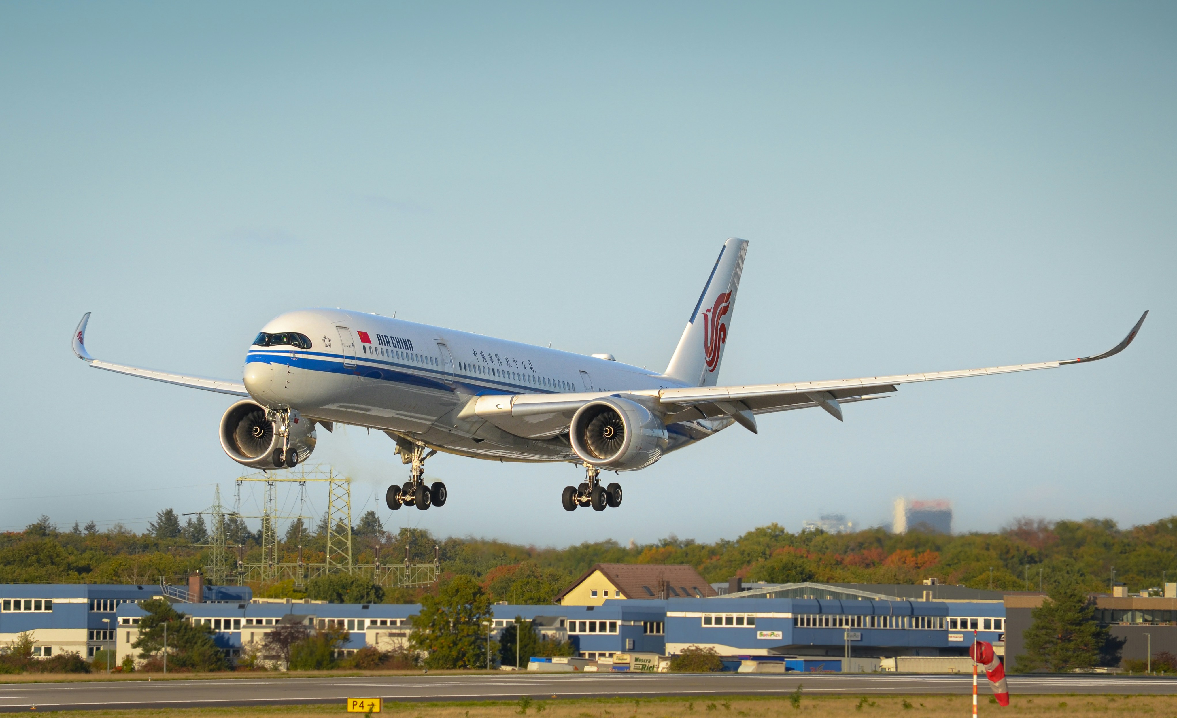 Turbulent ascent: a passenger jet glides above the runway at takeoff