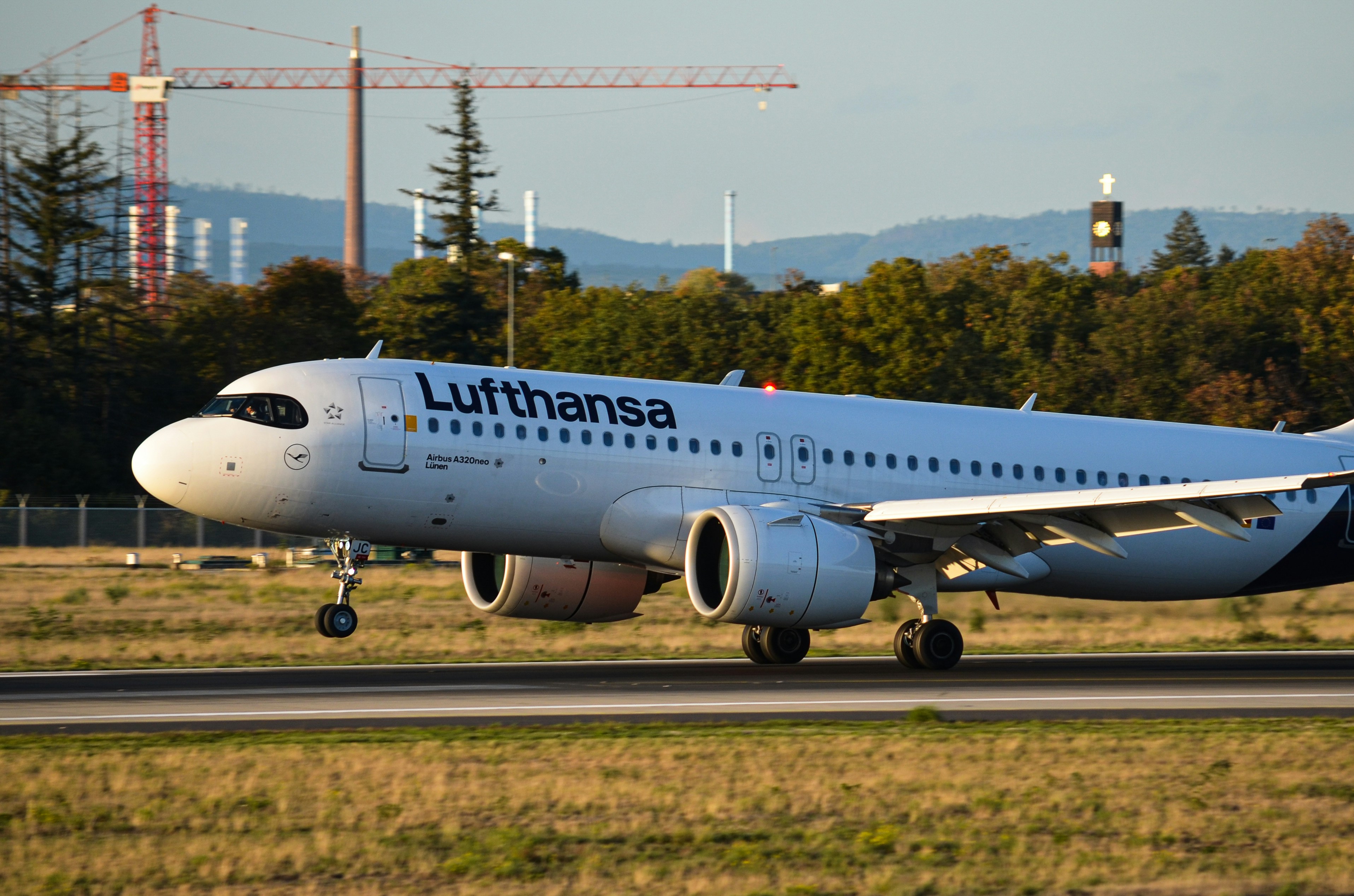 Lufthansa Twin-Engine Triumph: A Jet Touches Down on a Sunlit Runway