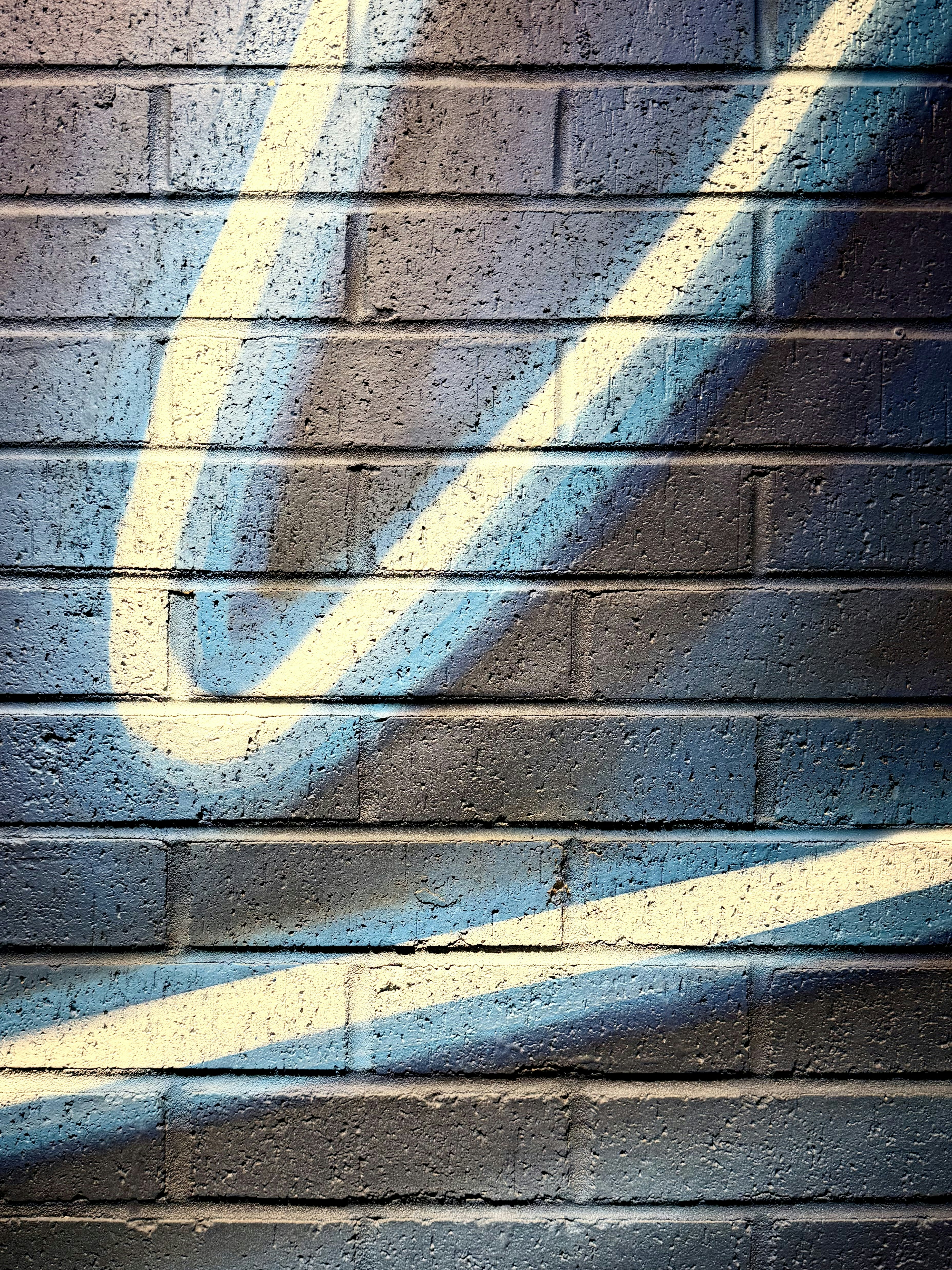 Blue Corners and Pale Arcs on Weathered Brick