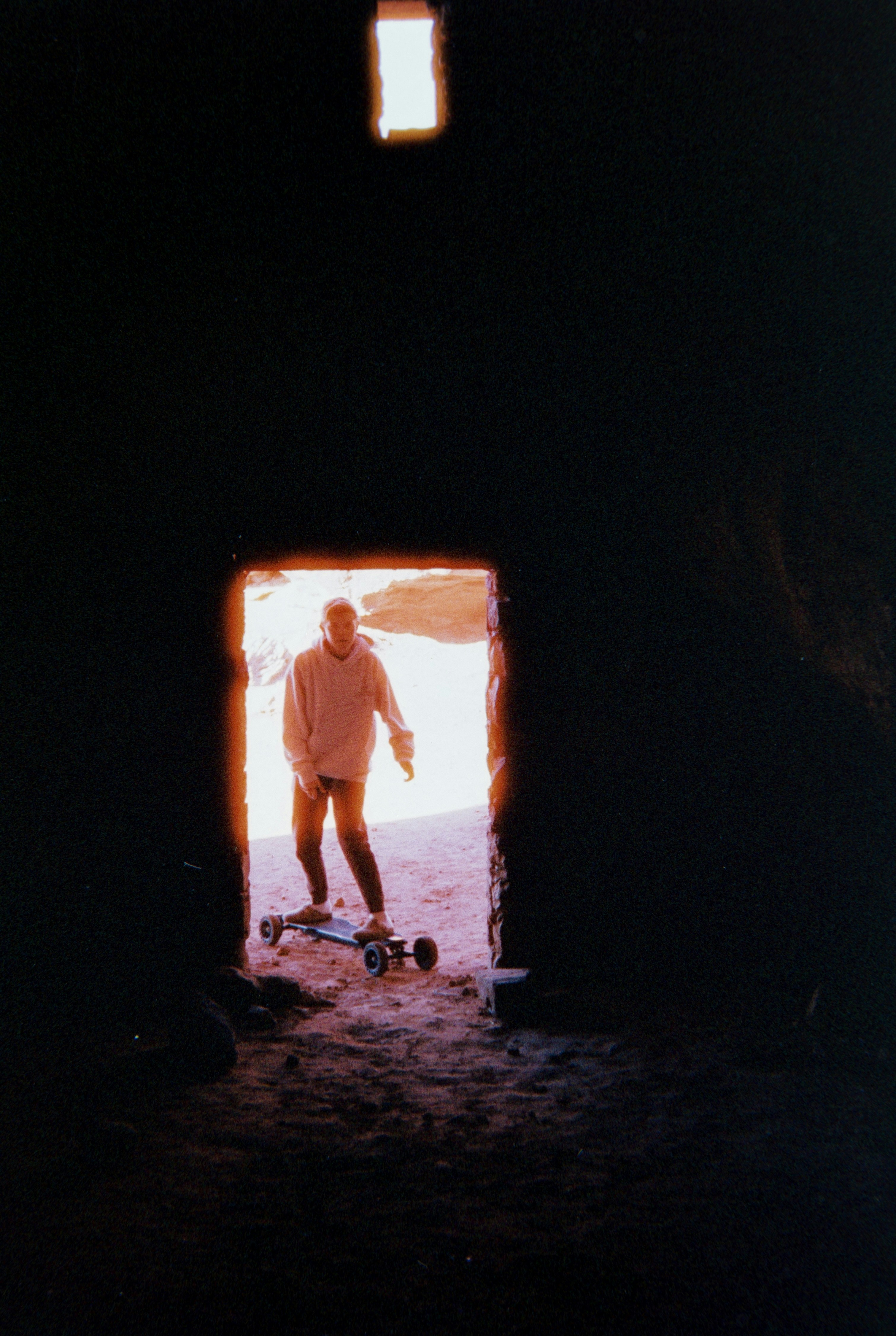 Skateboarder at Threshold: Leaving the Cave