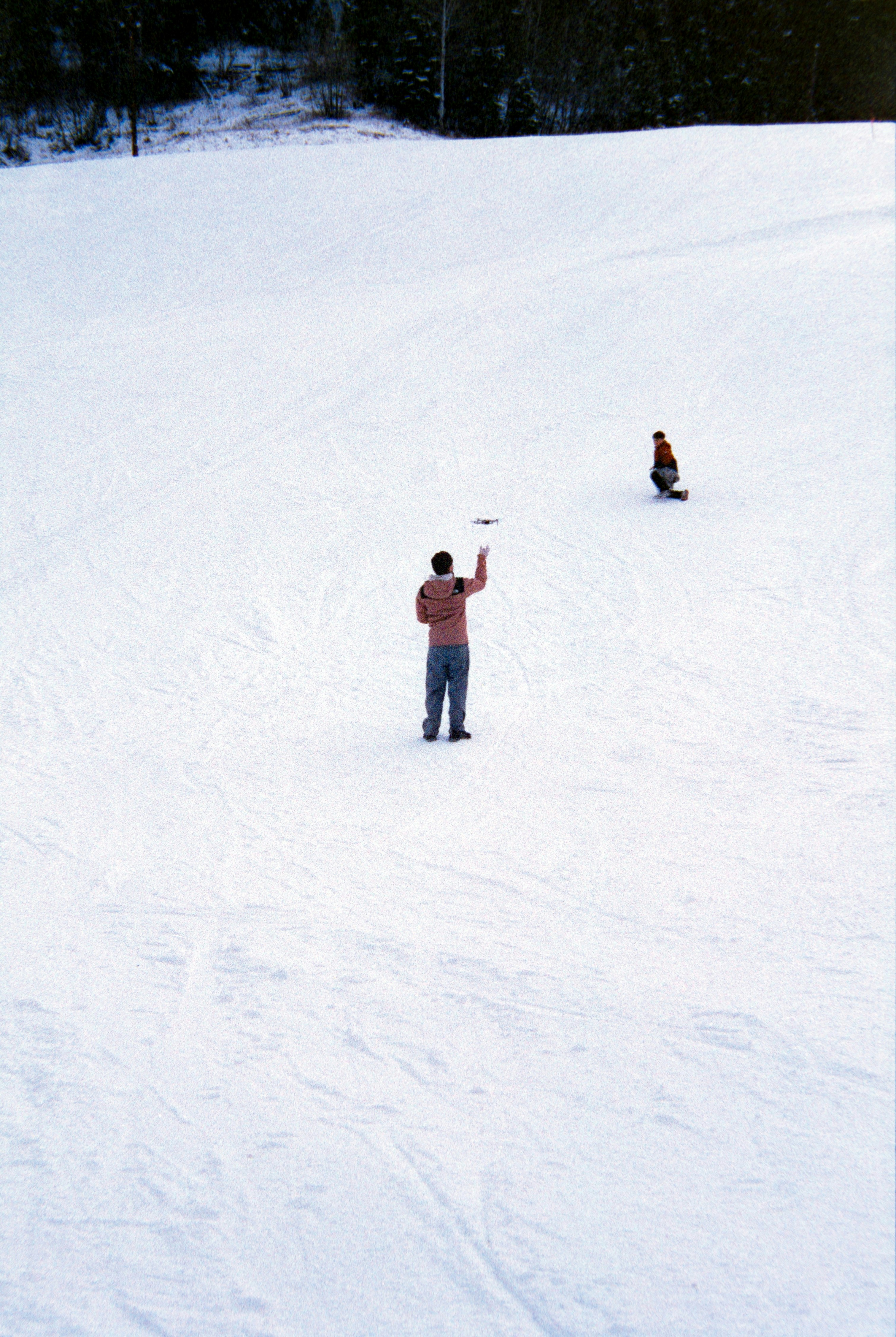 Snowbound Moment: A Red-Jacket Gesture on a Quiet Slope