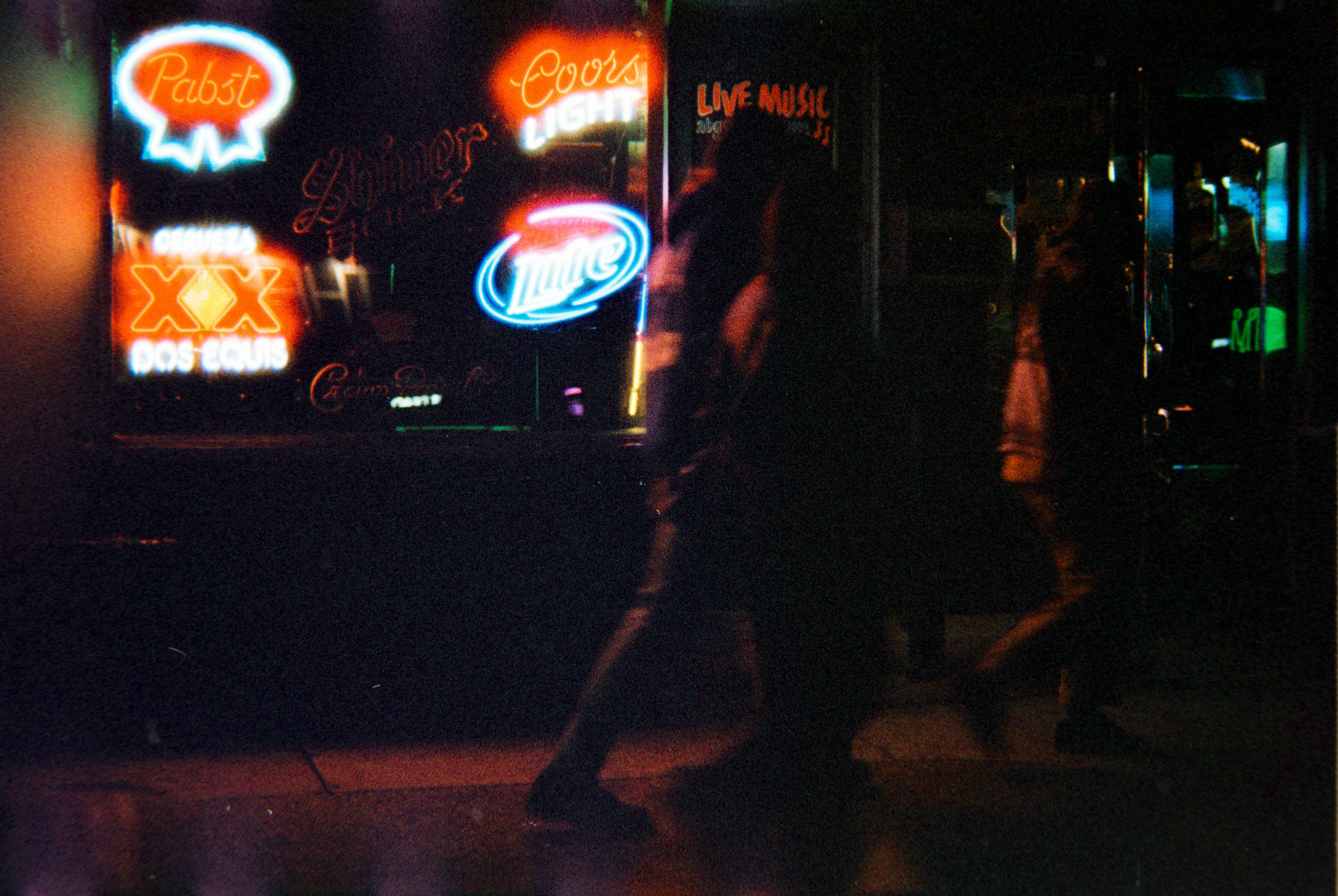 Neon Night Walk: Quiet Figures in a Glowing Alley