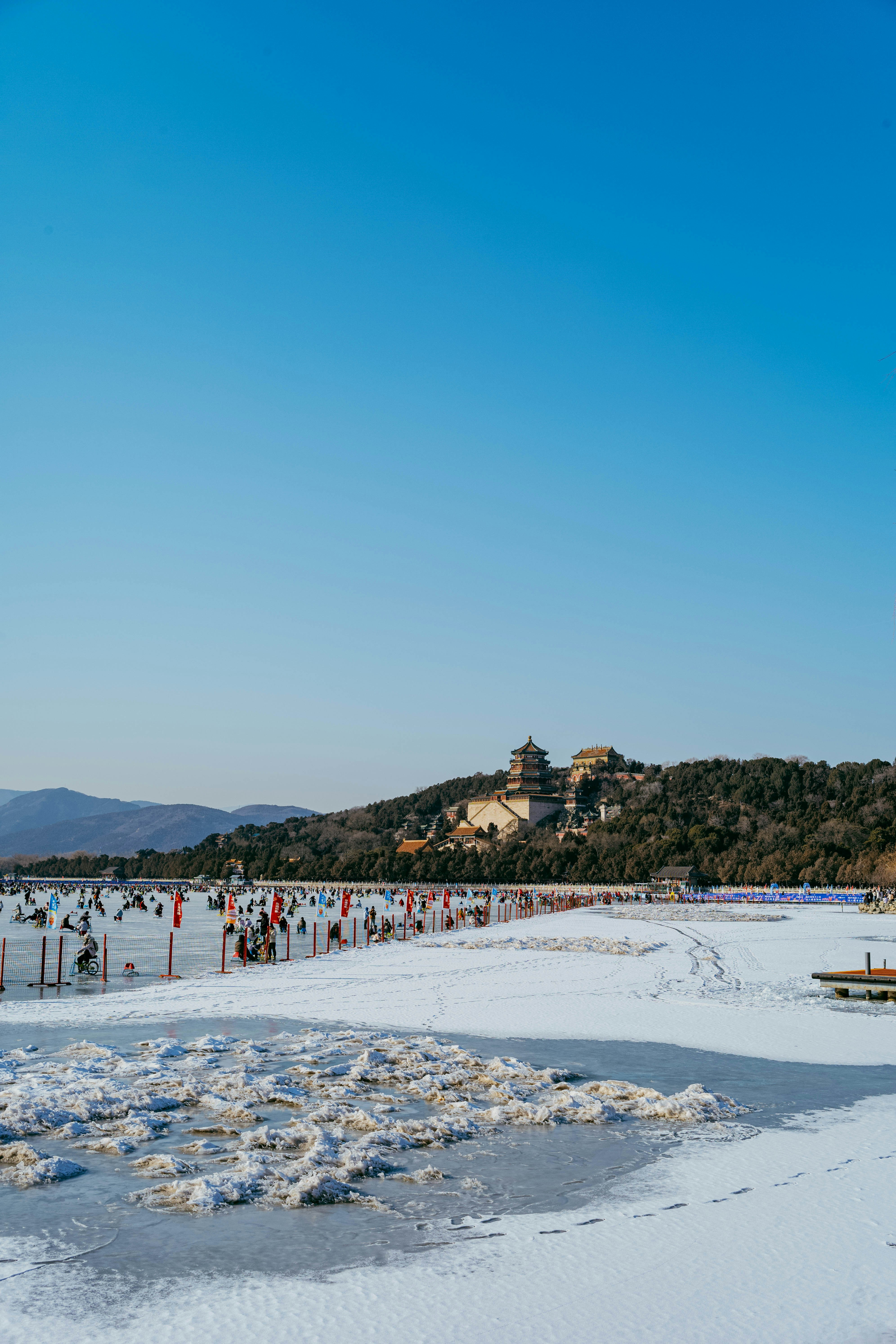 Winter Shoreline with Historic Cliffside Fortress under a Clear Sky