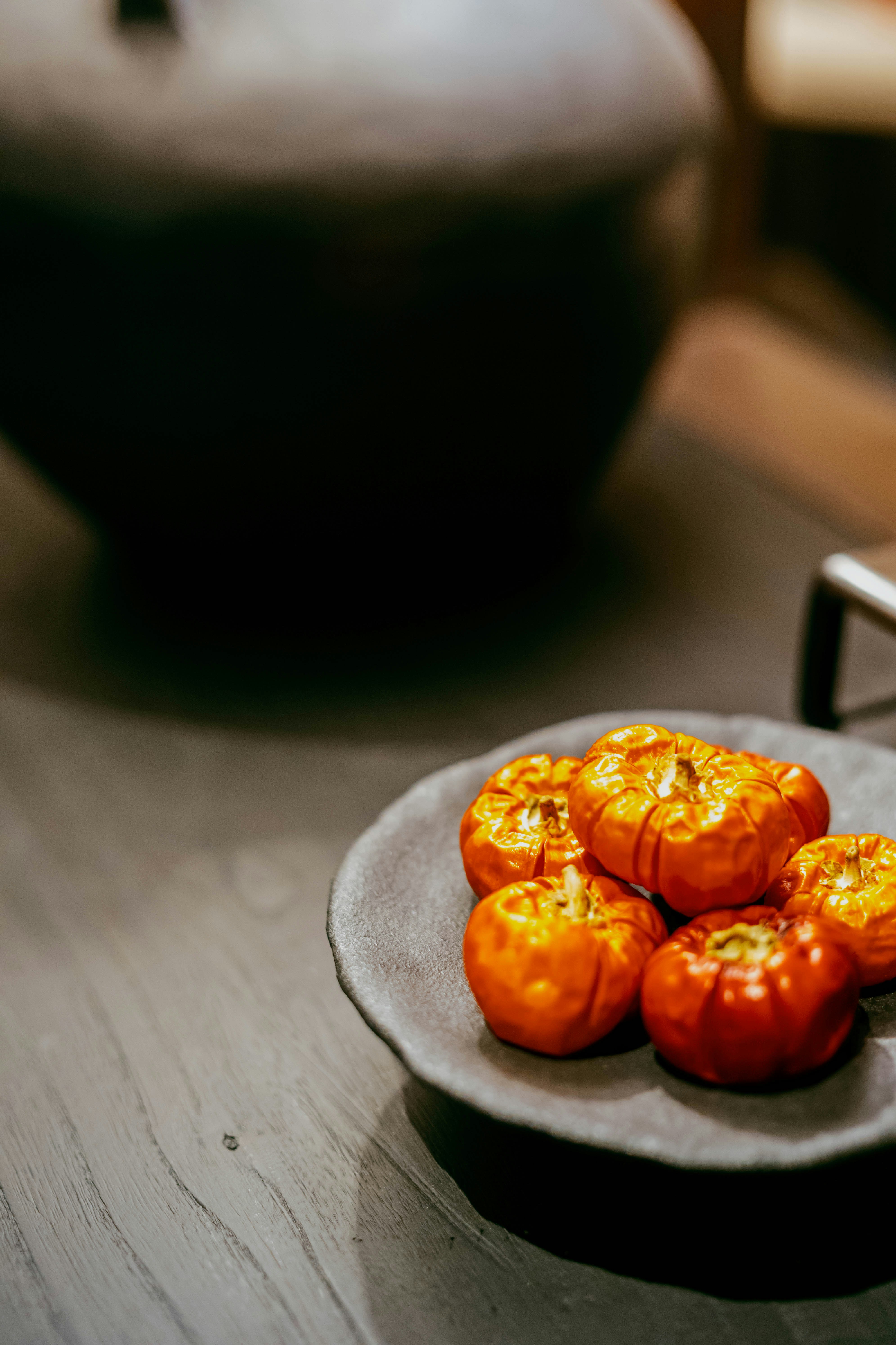 Charred Orange Pellets on a Dark Ceramic Plate
