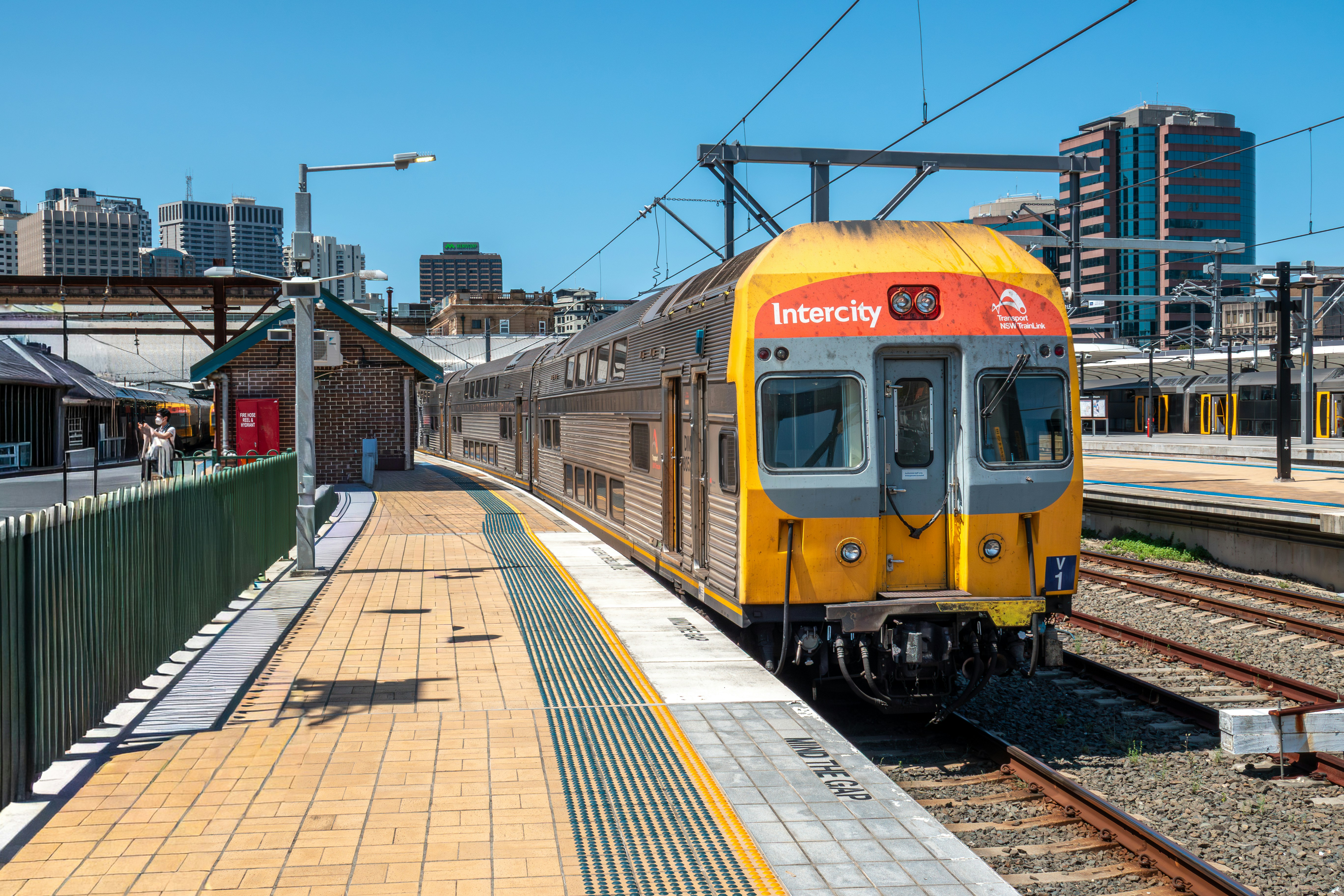 Yellow Intercity Lined Up at a Quiet Urban Platform