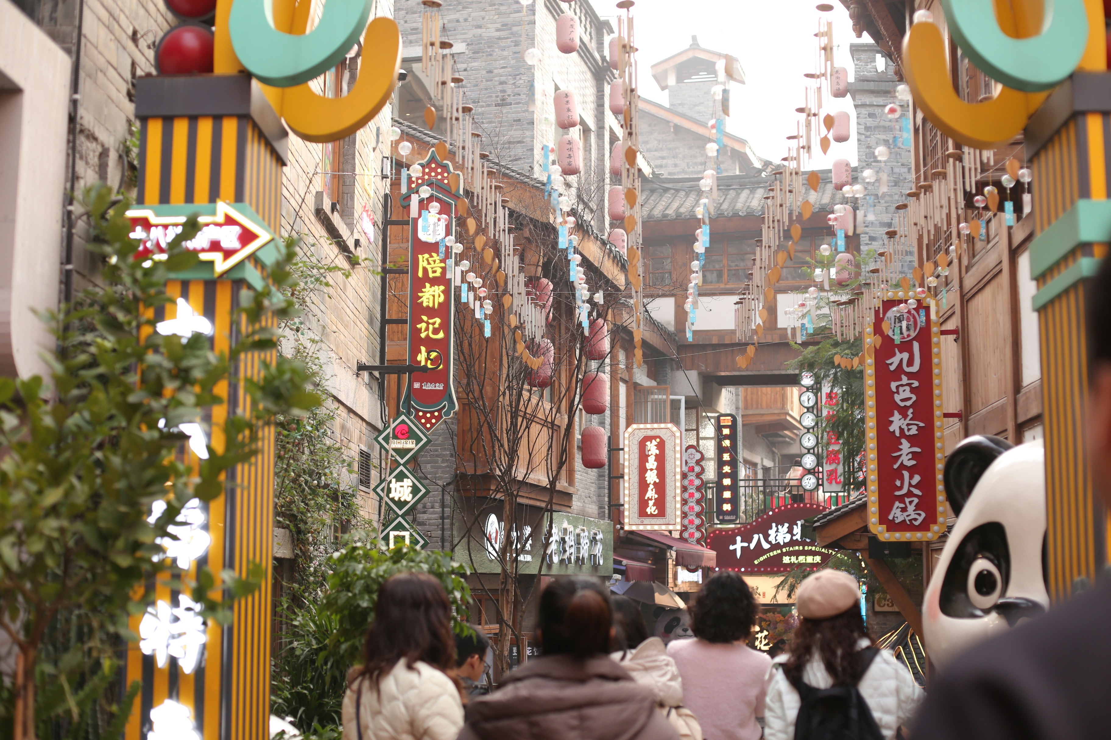 Neon-lined Alleyway: A Busy Street Scene Beneath Cherry Lanterns