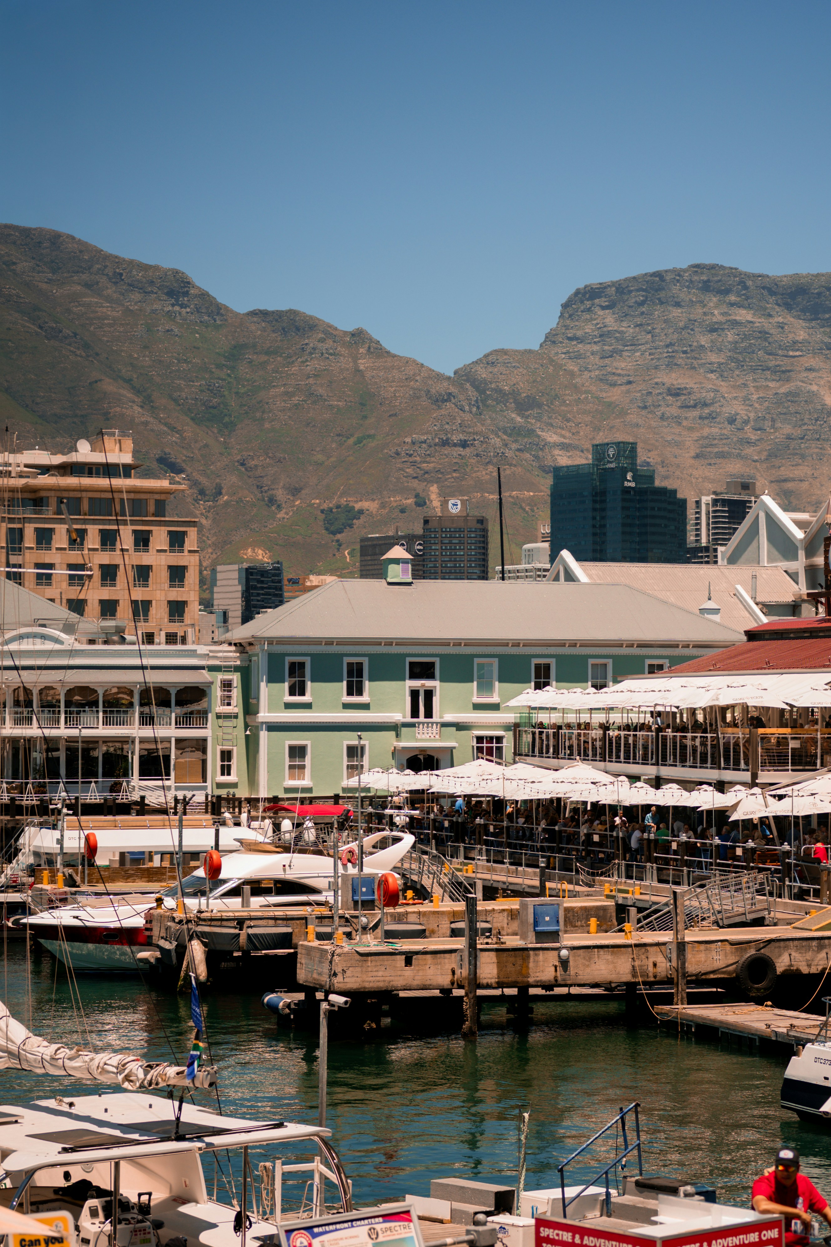 Harborfront in pastel hues beneath the coastal hills