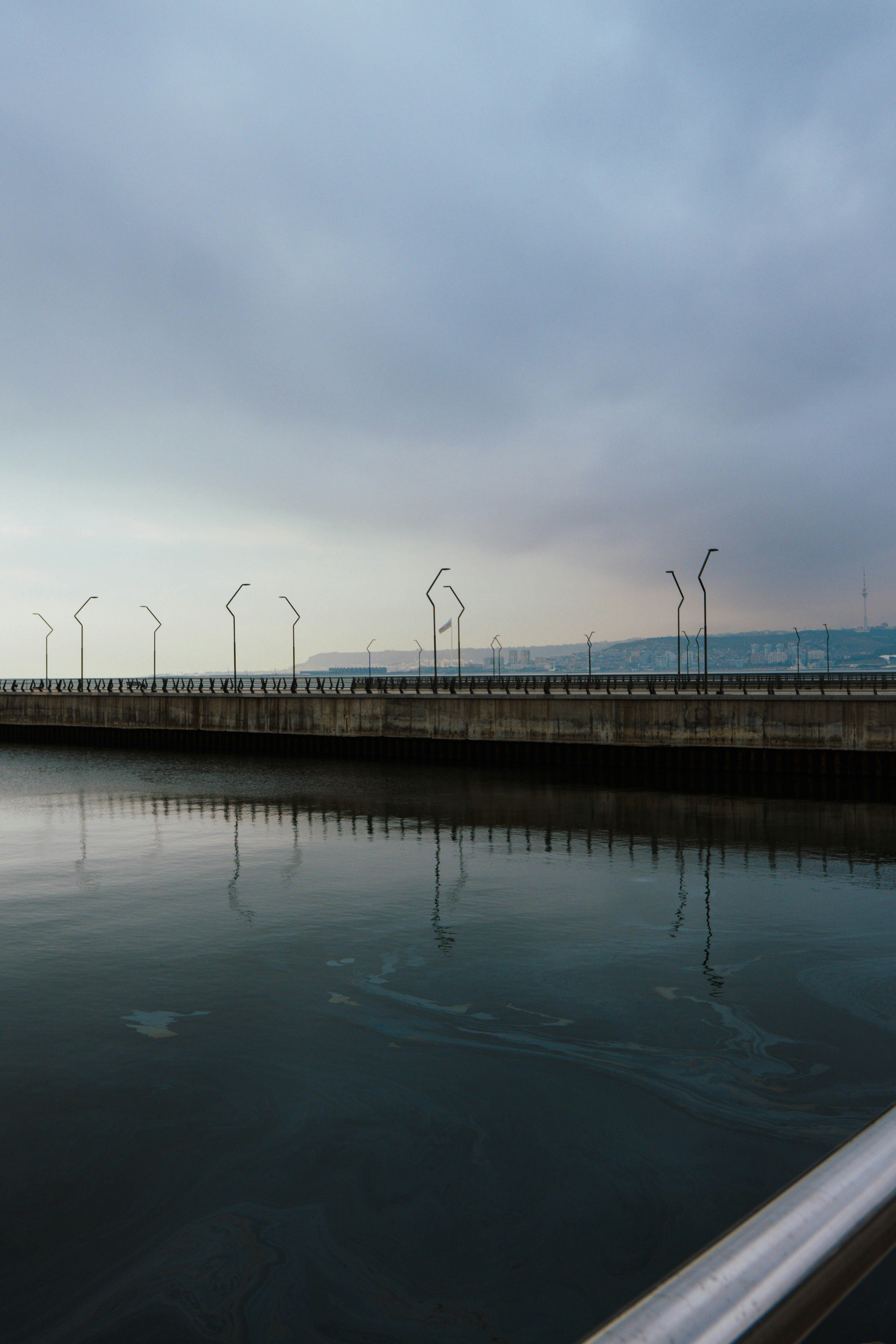 Midday Parapet Stillness over an Industrial Waterfront