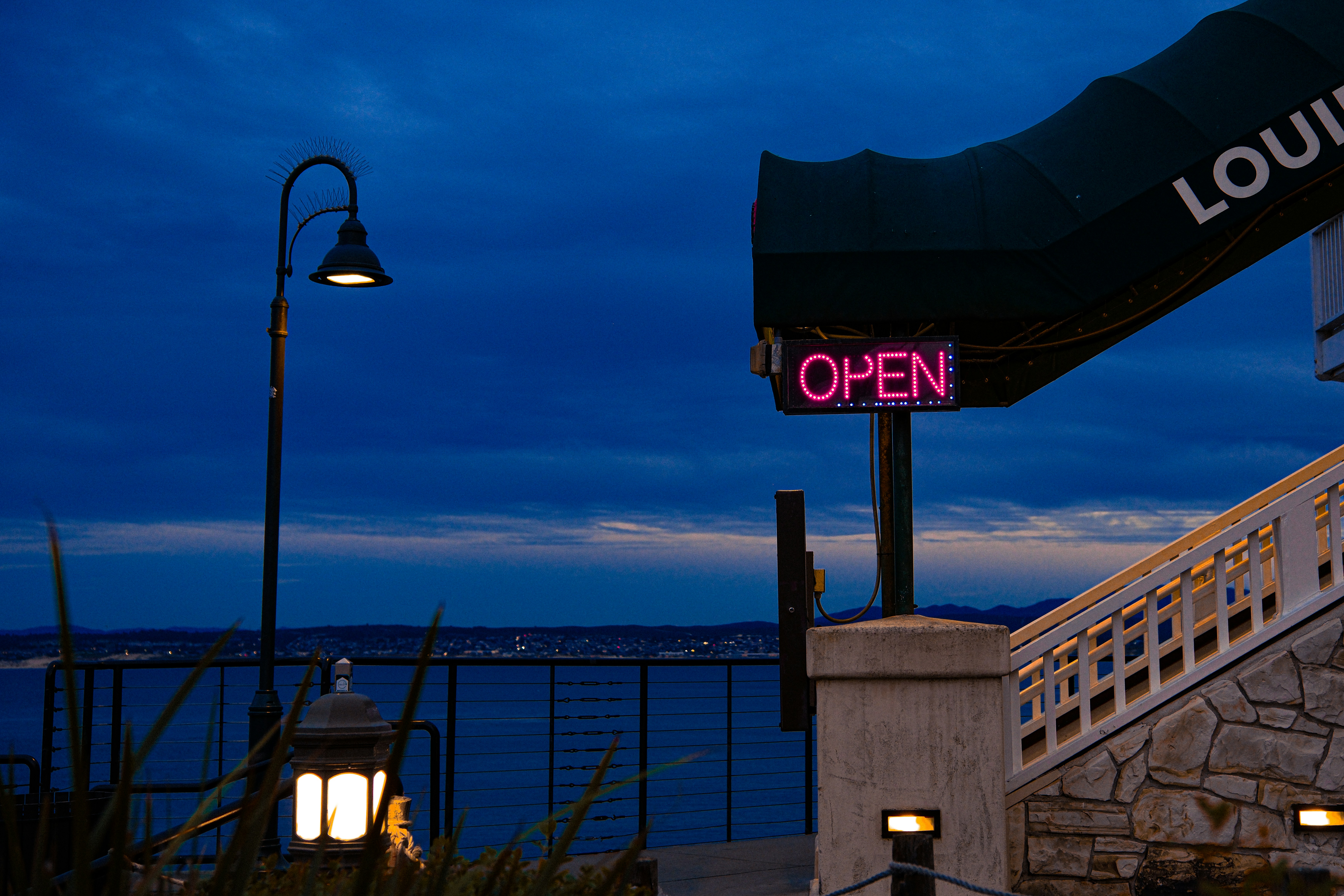 Open Sign Overlooking the Night Pier