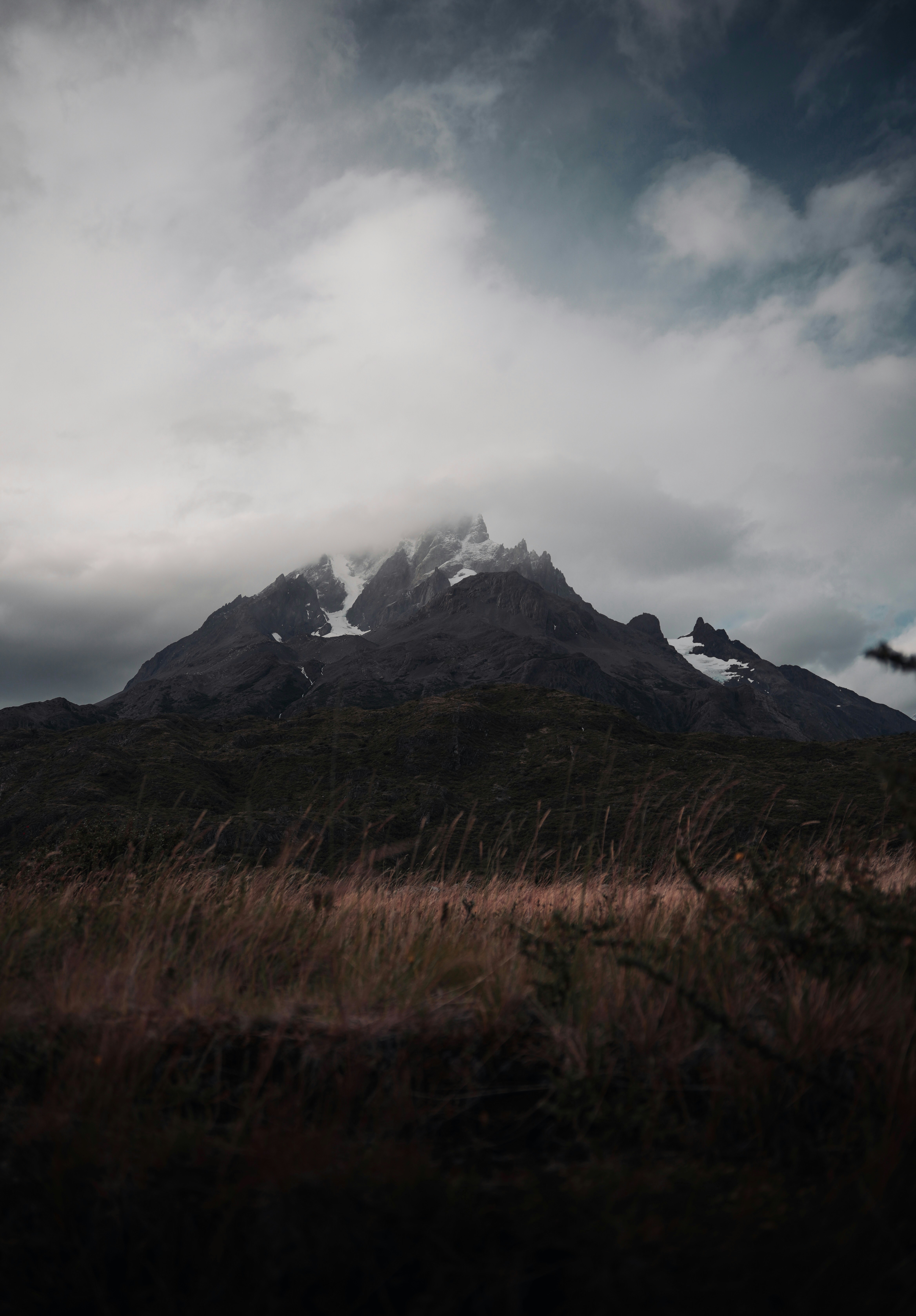 Peak Veil over Prairie: A solitary mountain under a brooding sky