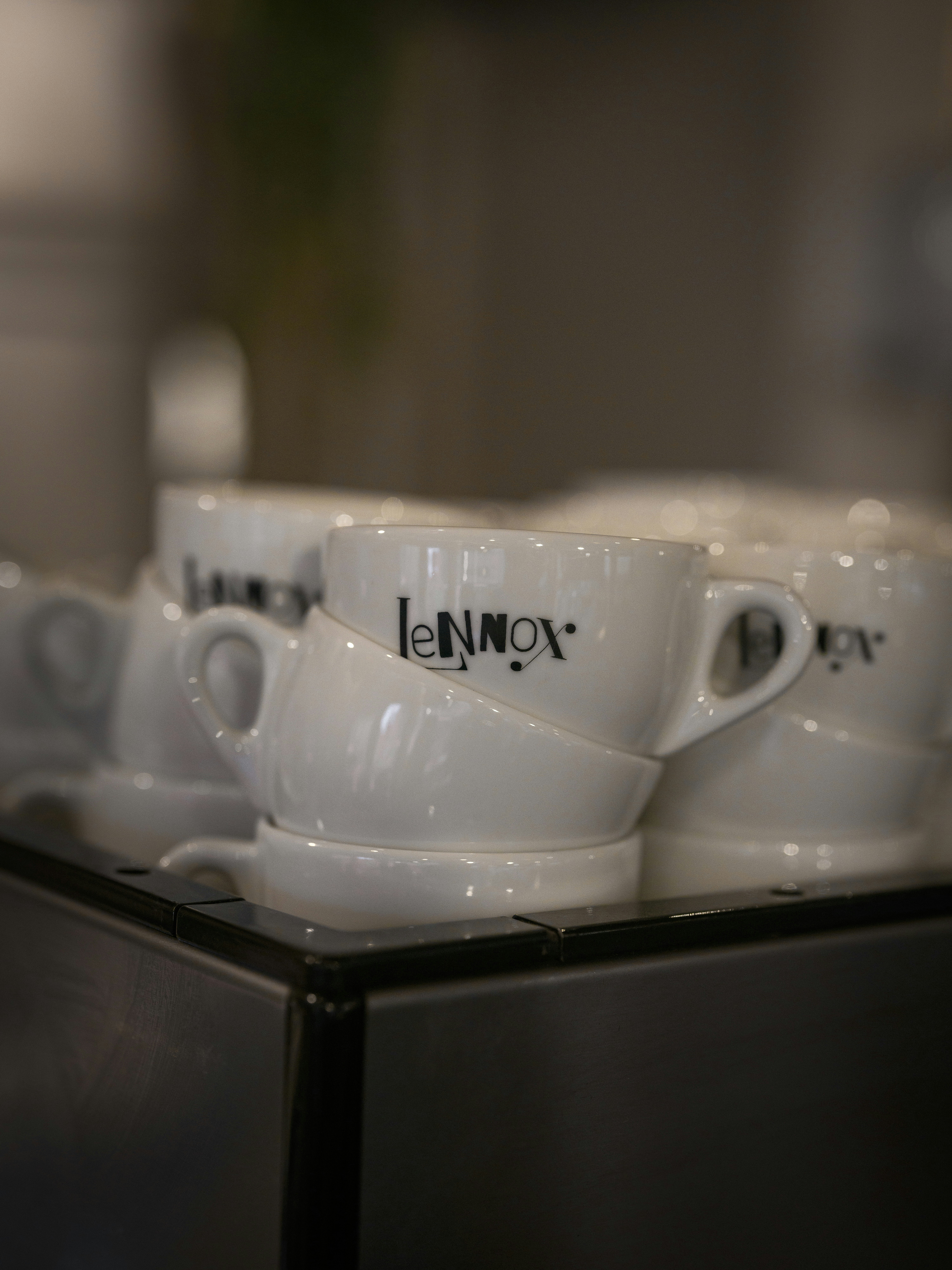 Stacked Espresso: A Row of LeNnox Cups on a Stainless Shelf