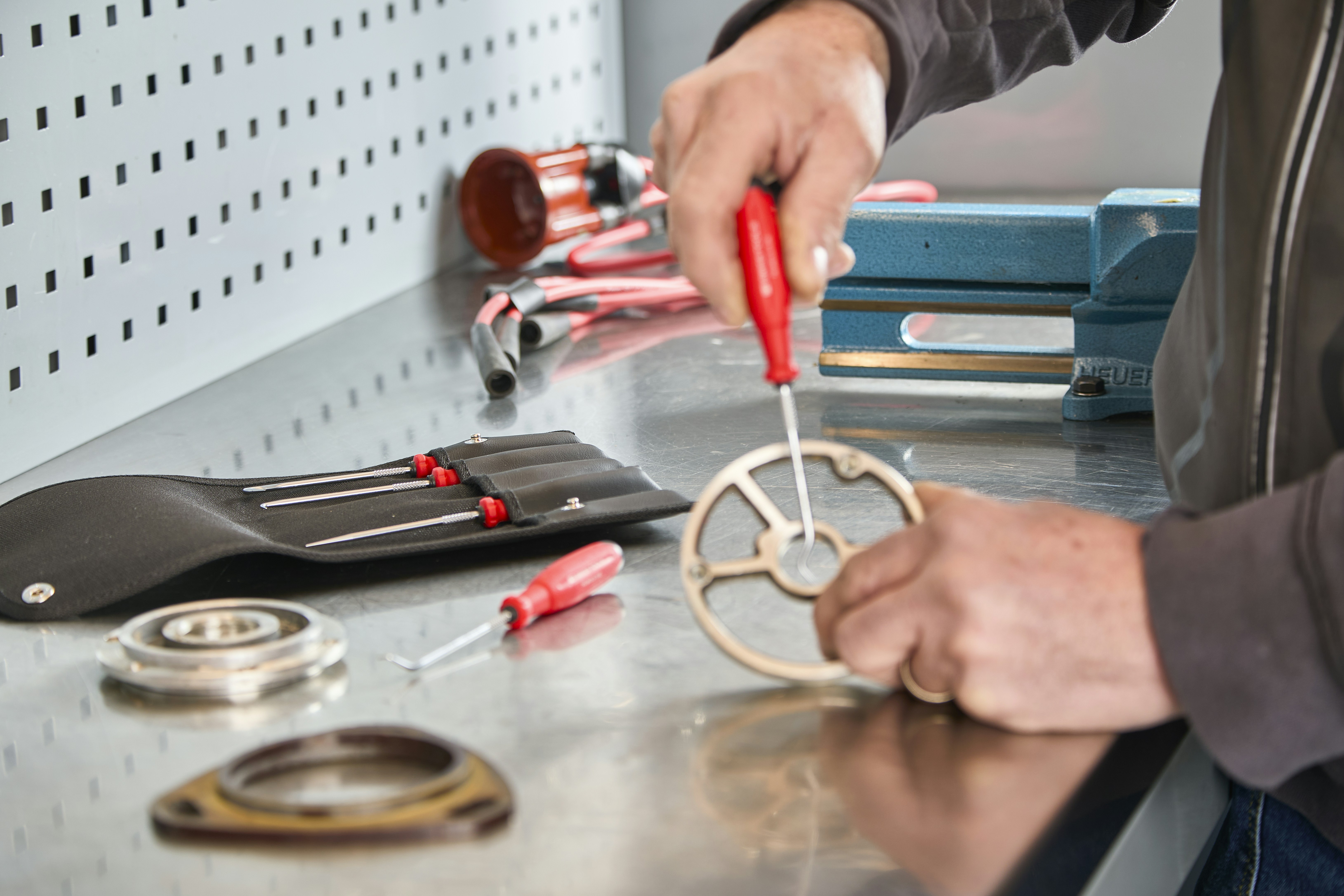 Precision in Hand: A Technician Soldering a Small Rotary Component