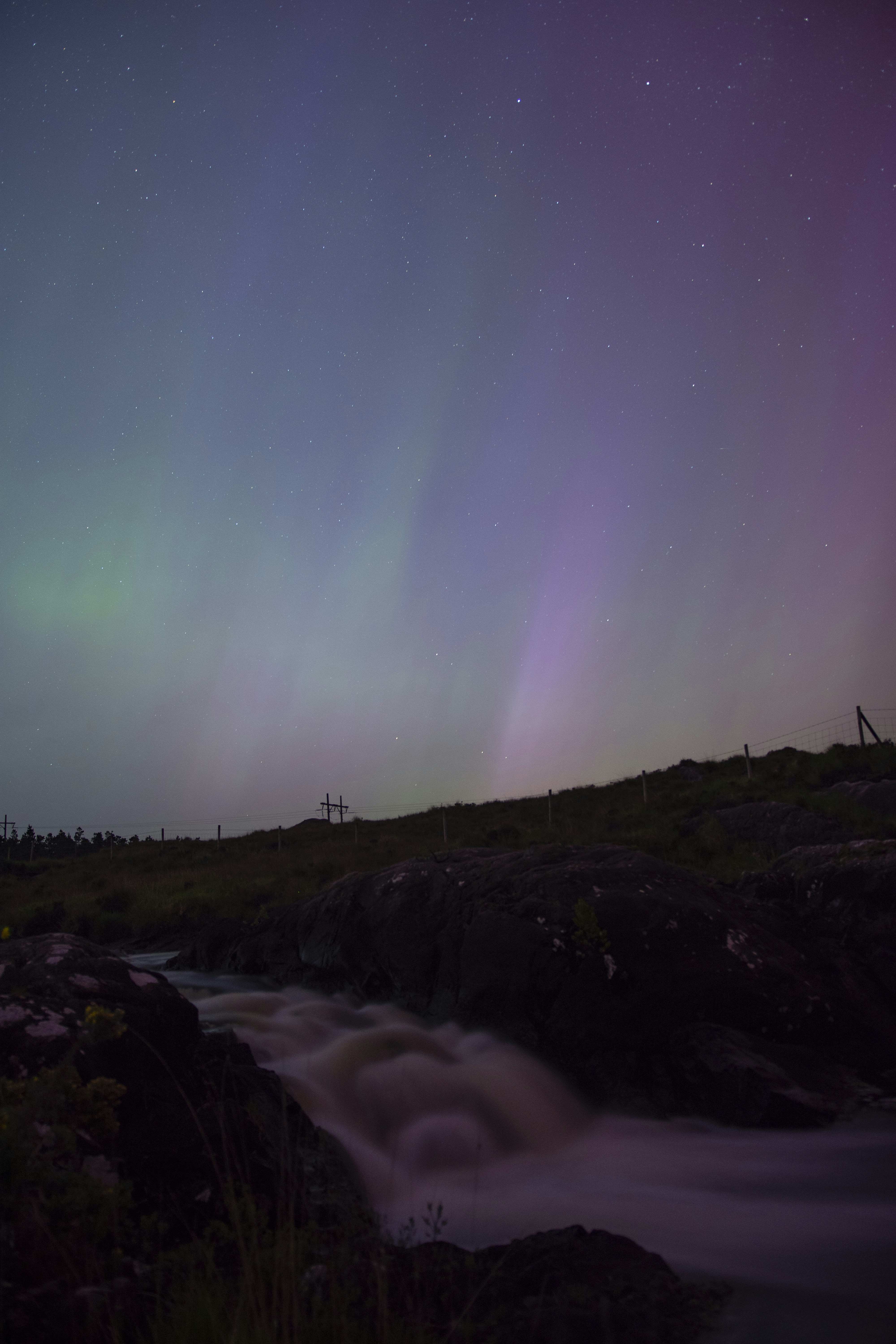 Aurora Over the Rift: Night Sky Dances with a Moonlit Vale