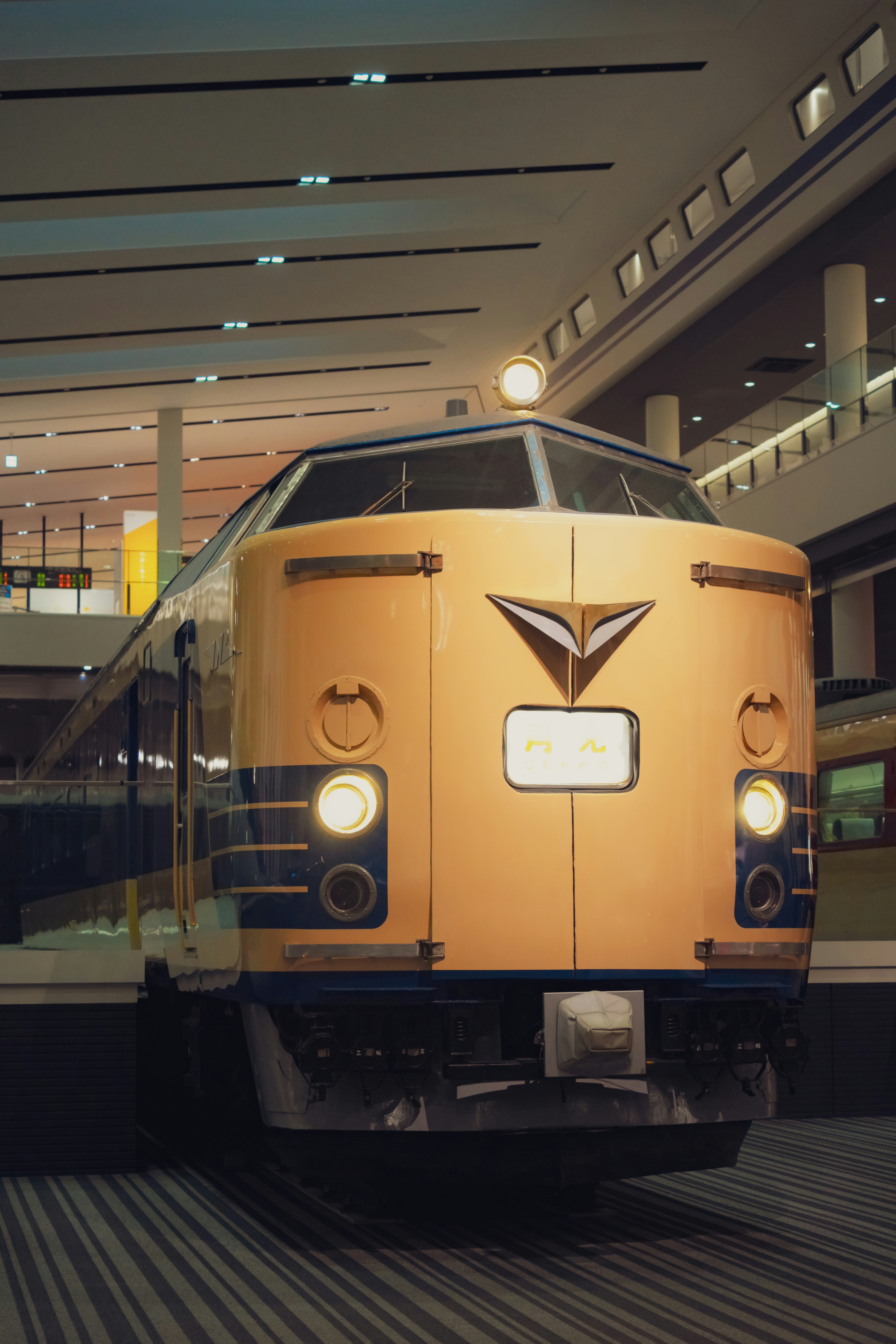 Golden locomotive in a sunlit transit hall