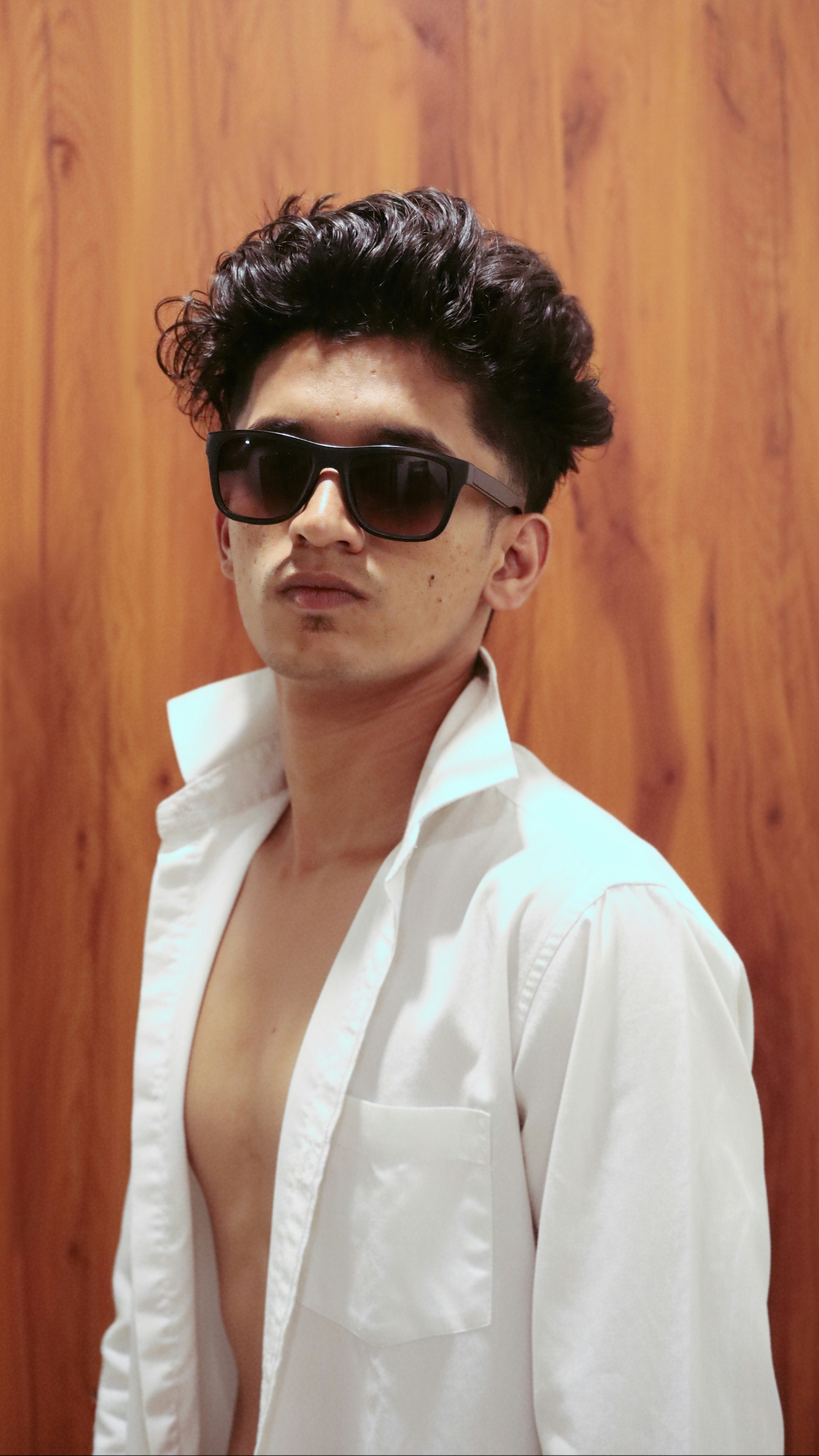 Shadowed Charisma: A Sunglassed Confident in White