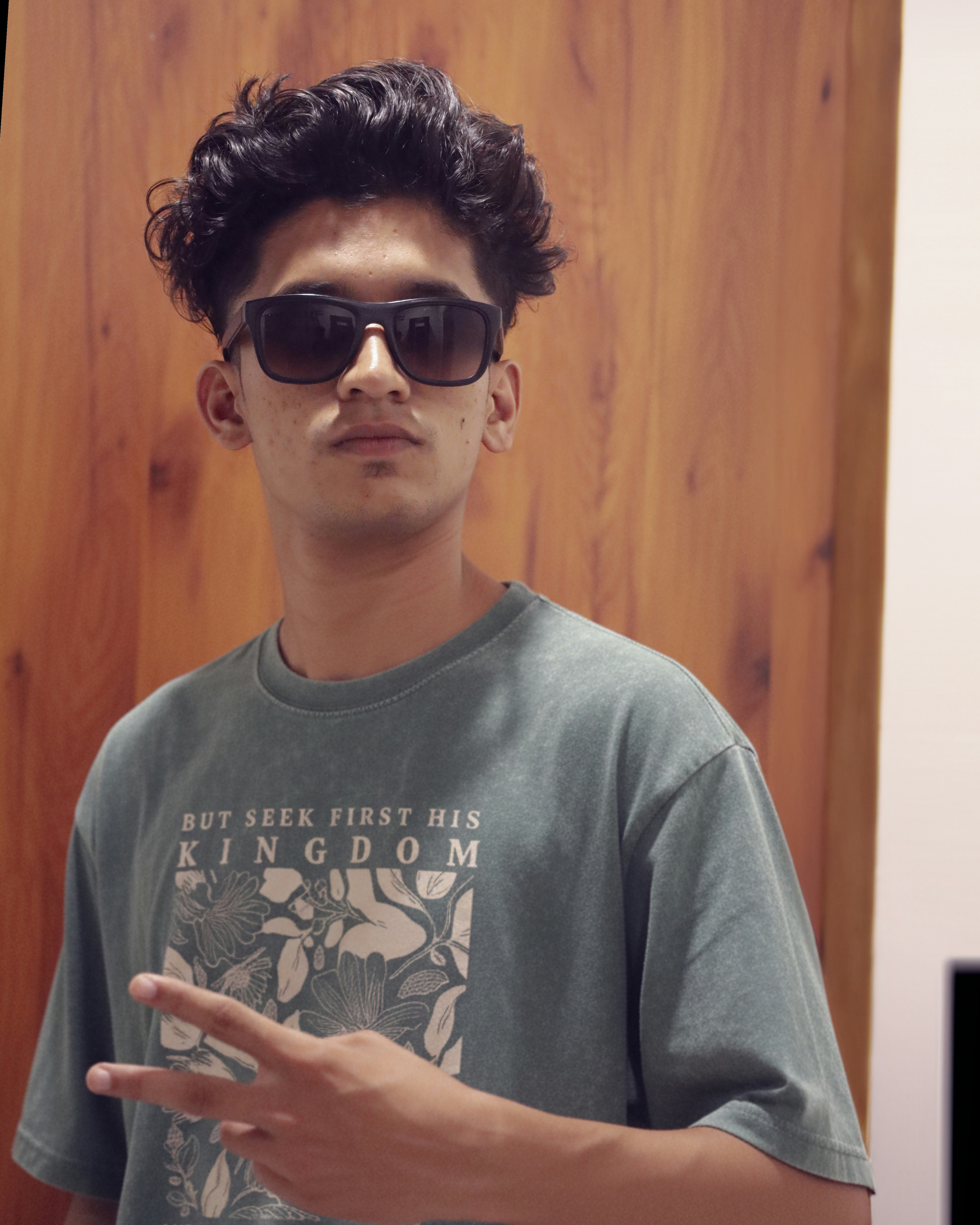Shaded Confidence: A Portrait in Streetwear and Shadowed Gaze