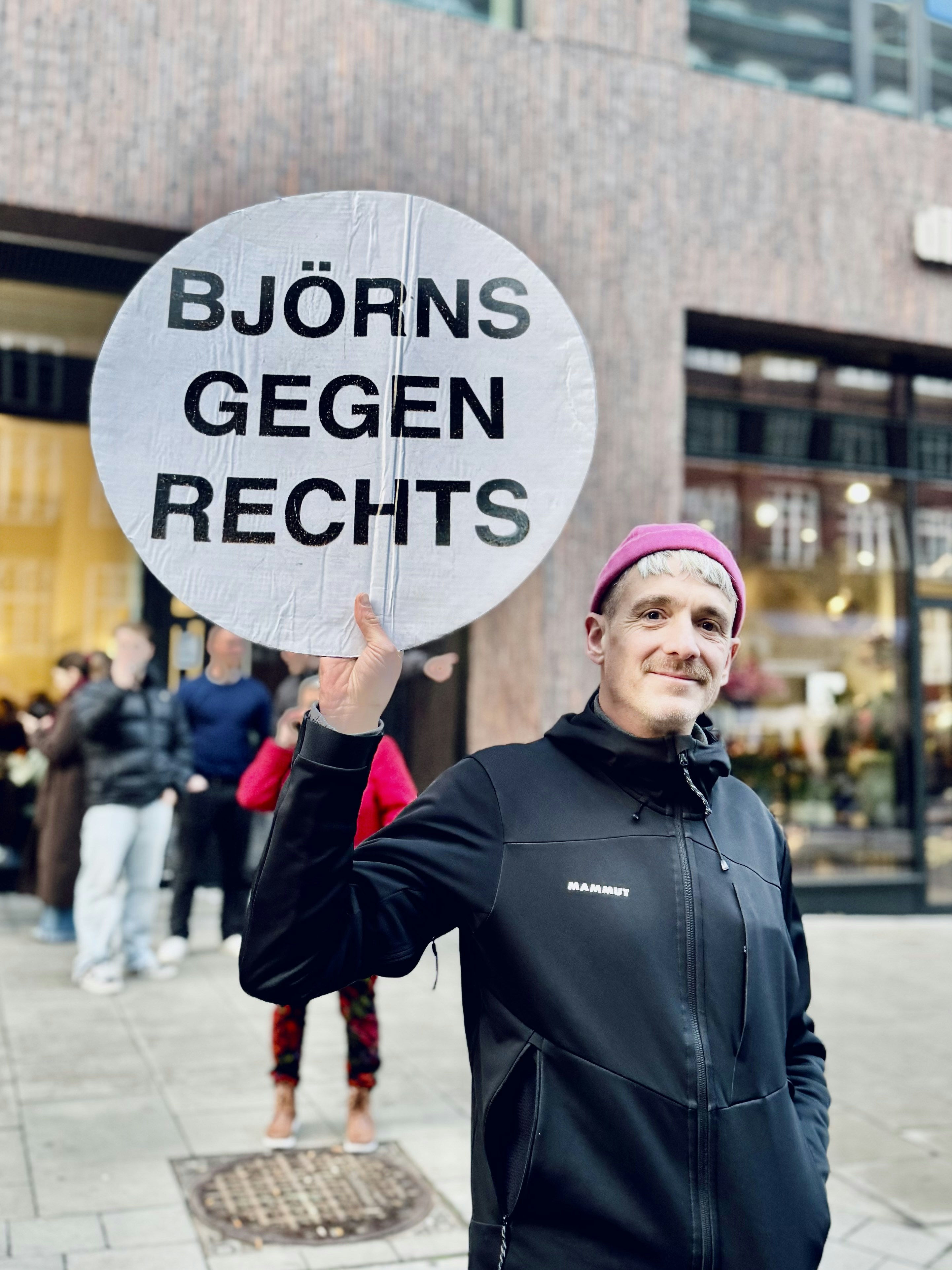 Protester with Round Sign in Urban Street Scene