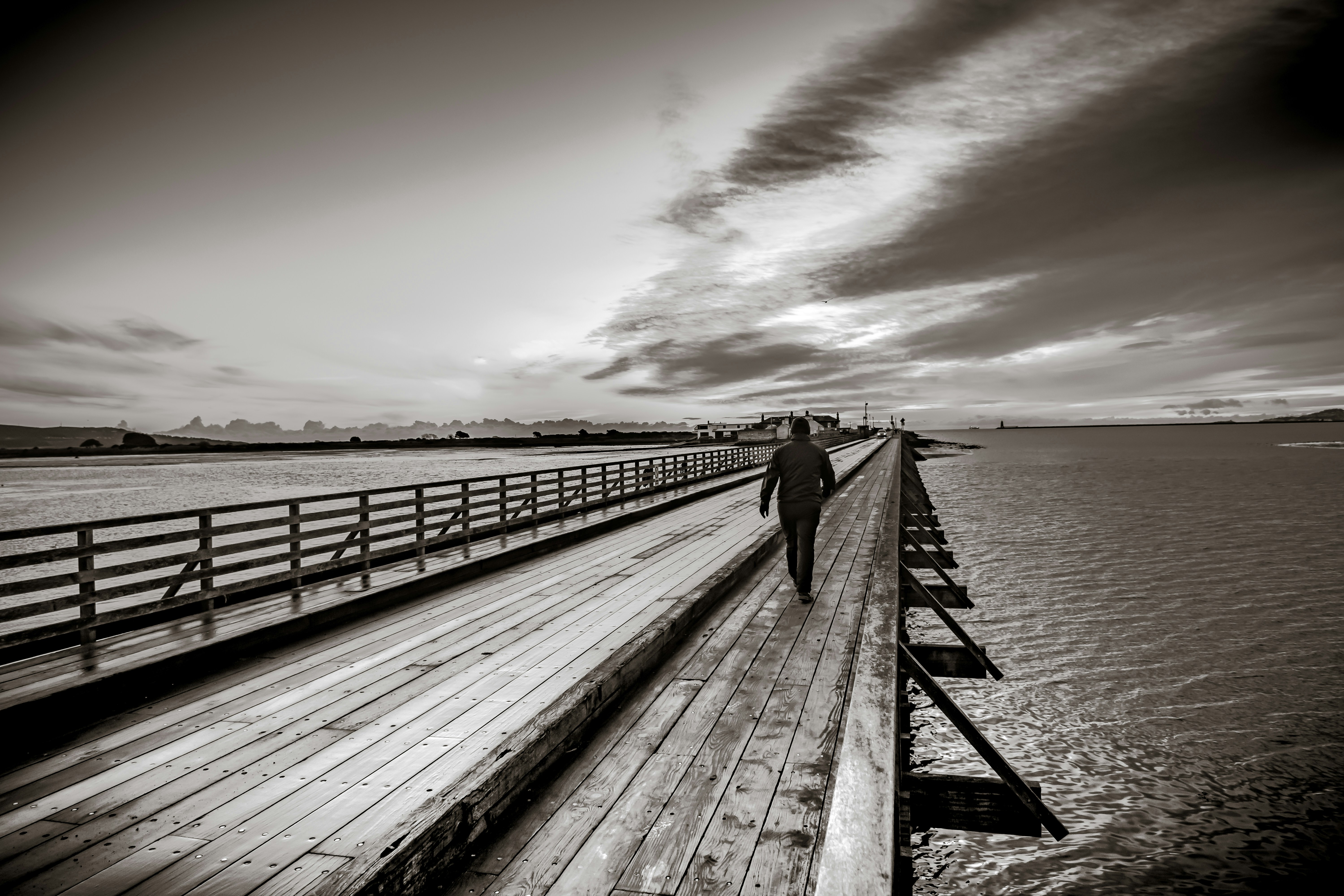 Lonely Walker at the End of the Pier