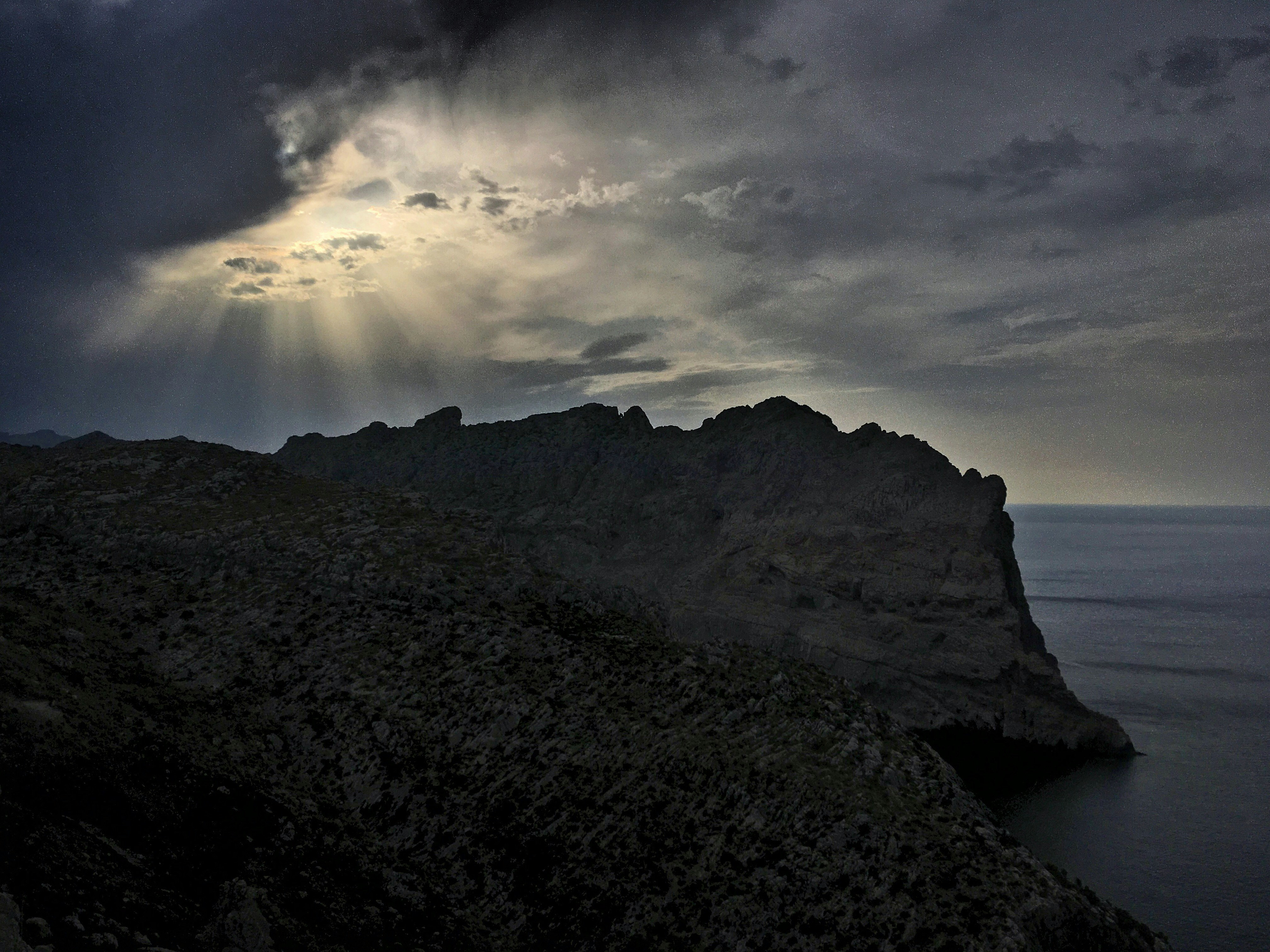 Sunbreak Over the Cliff: Quiet Drama on a Dark Coastal Vista