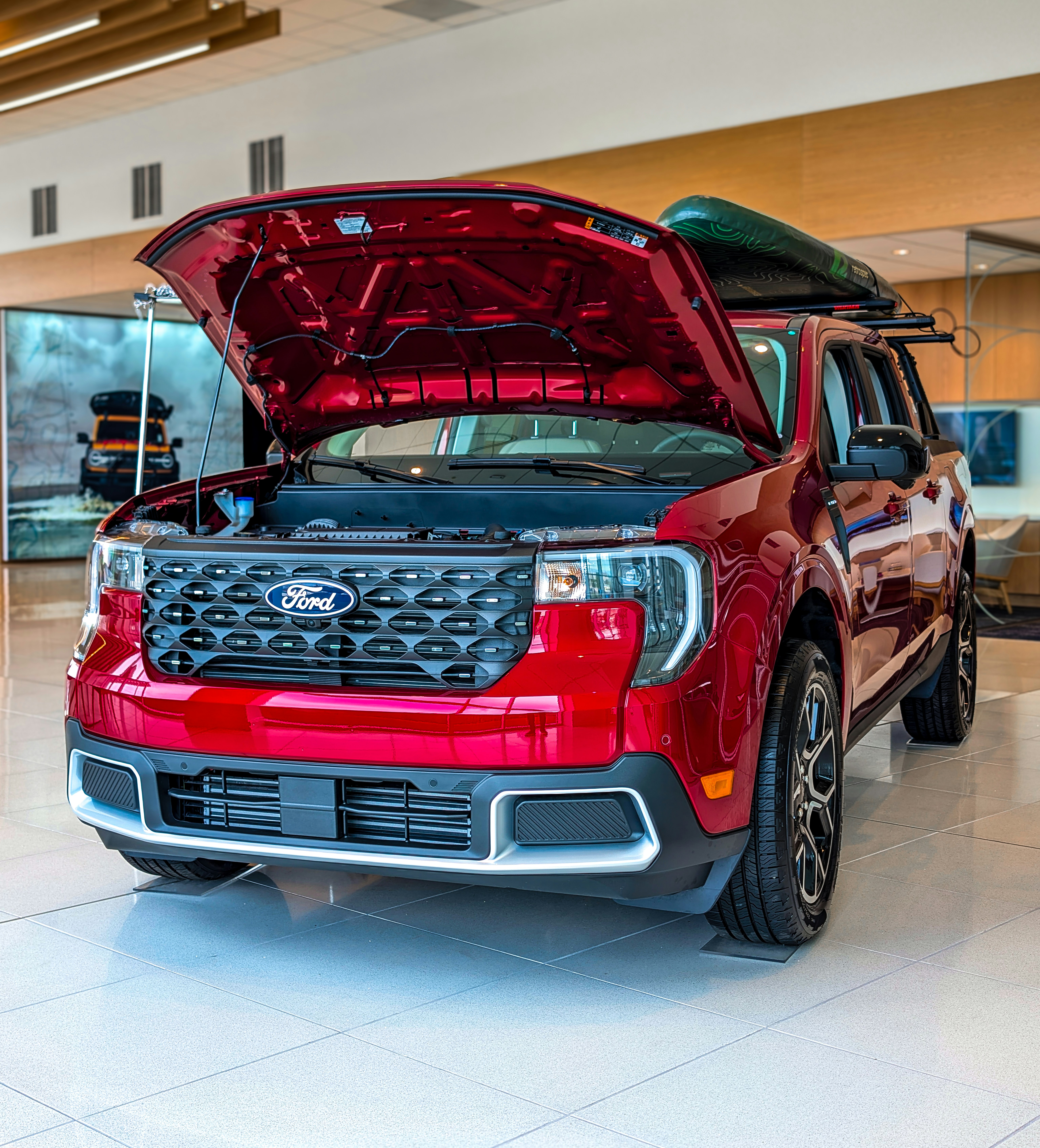 Red Ford Pickup with Hood Open in Showroom