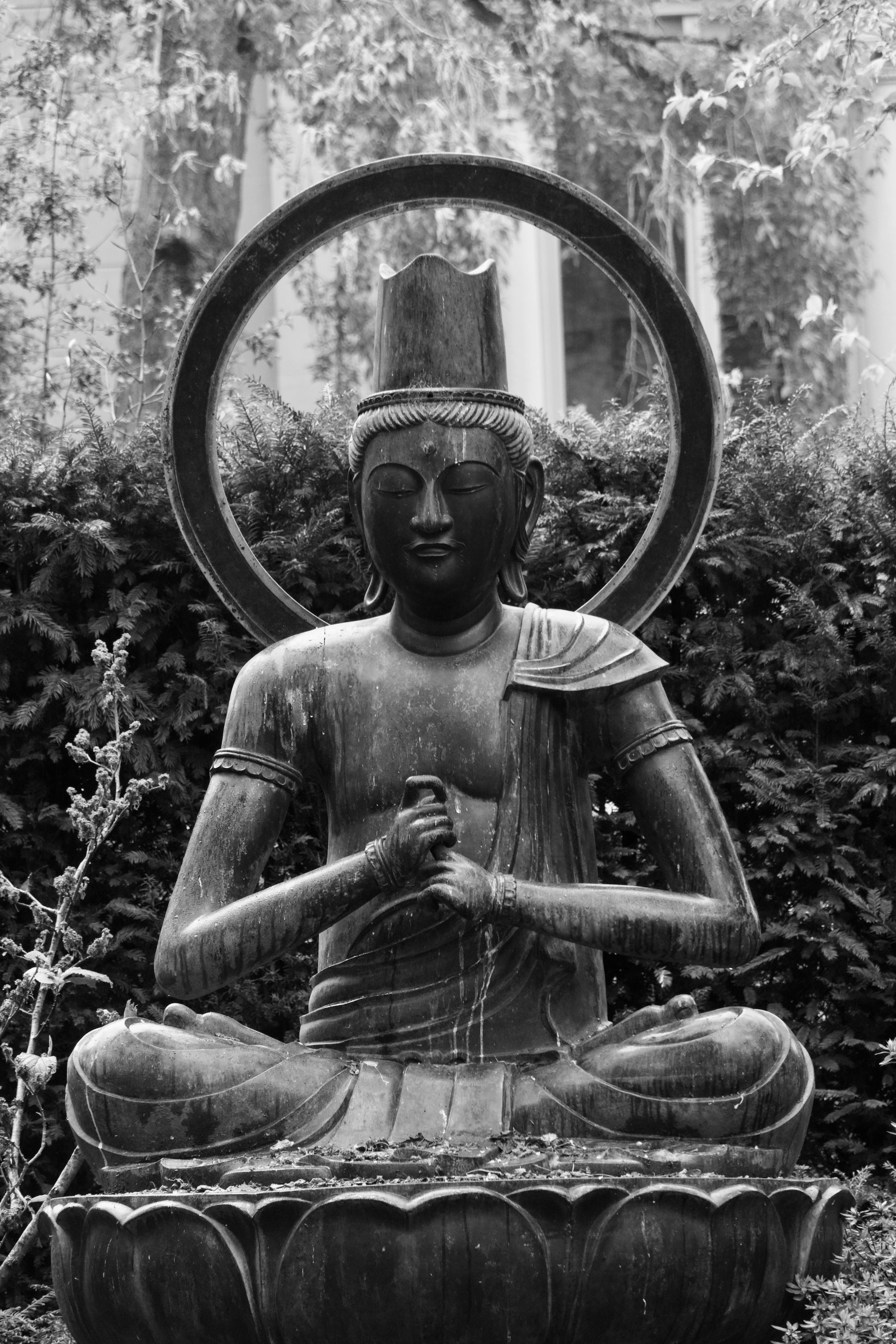 Meditative Silence: A Stone Buddha Framed by a Circular Halo