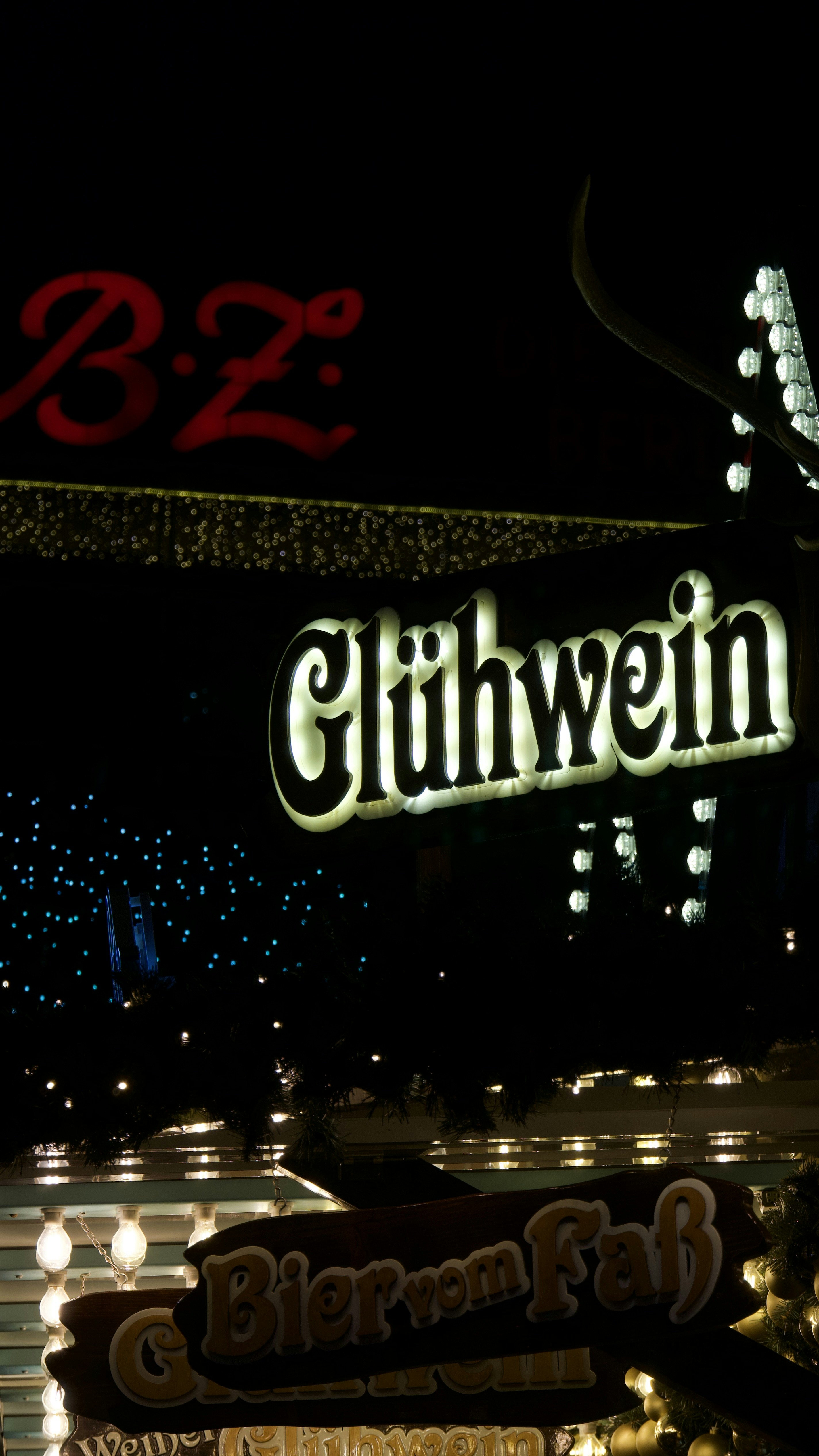 Gluhwein Glow: Neon Signage Amid Christmas Market Night
