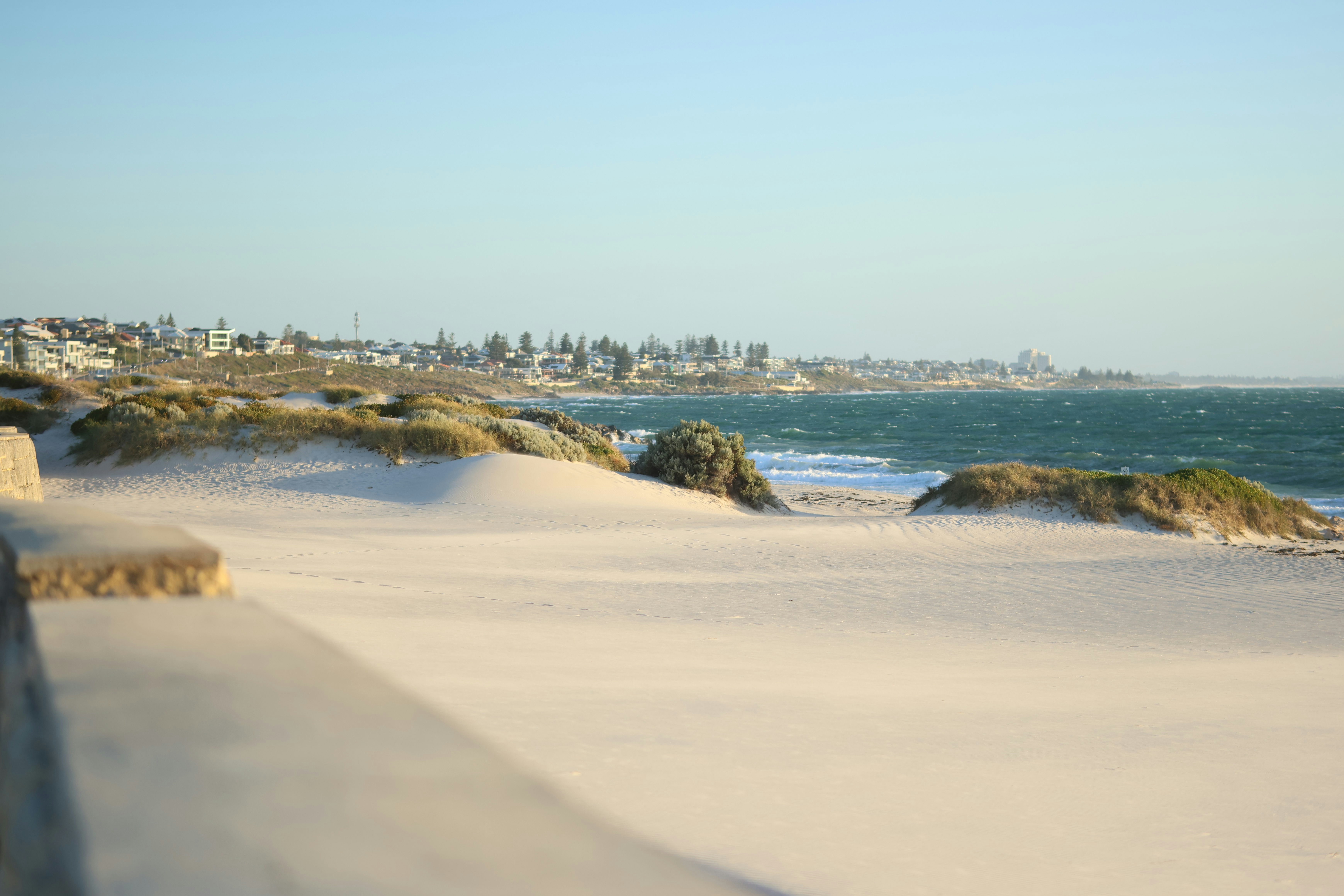 Coastal Dunes and Quiet Sea: A Sunlit Strip from the Boardwalk
