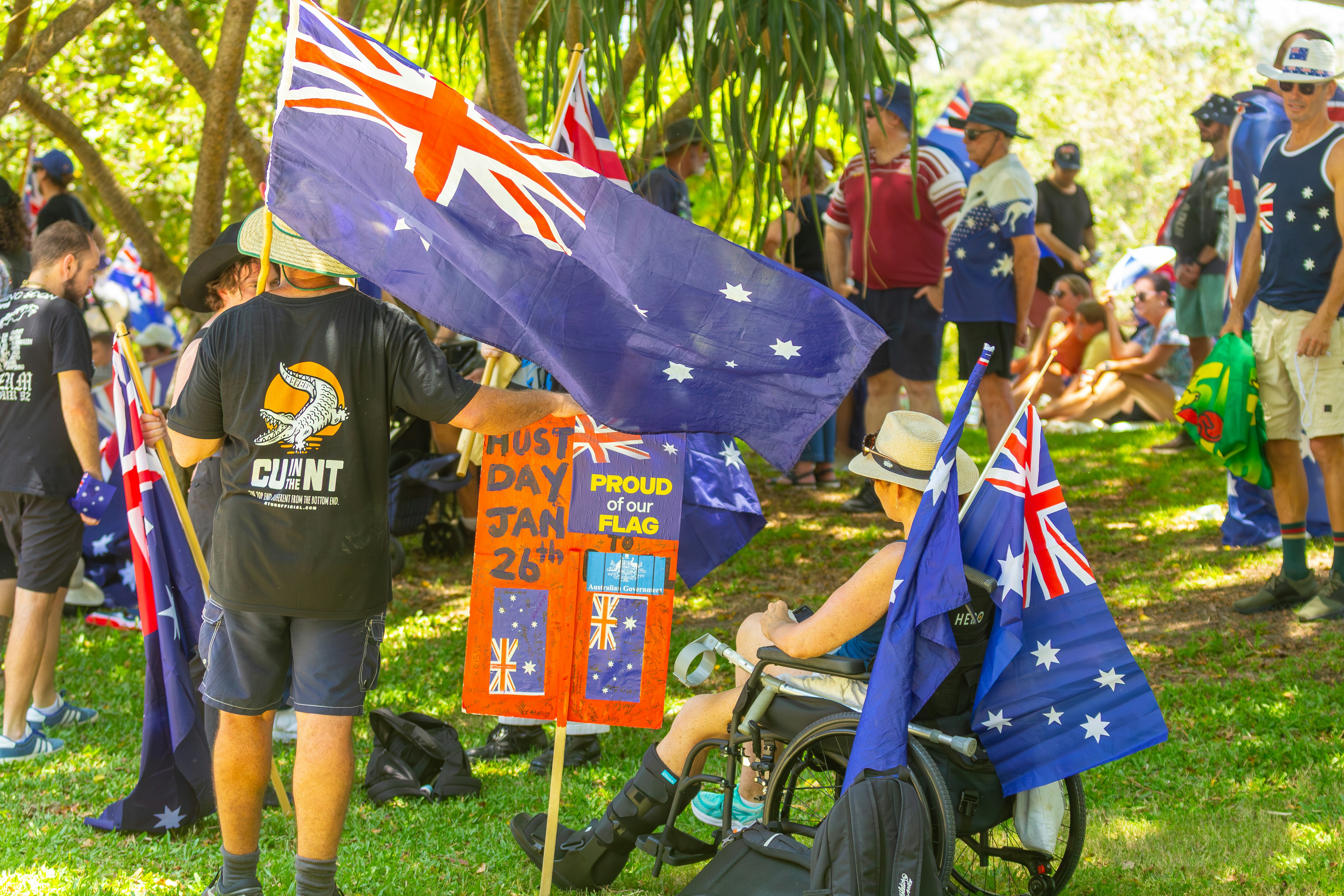 Australian Flags and Hiker Spirit at a Sunlit Park Rally