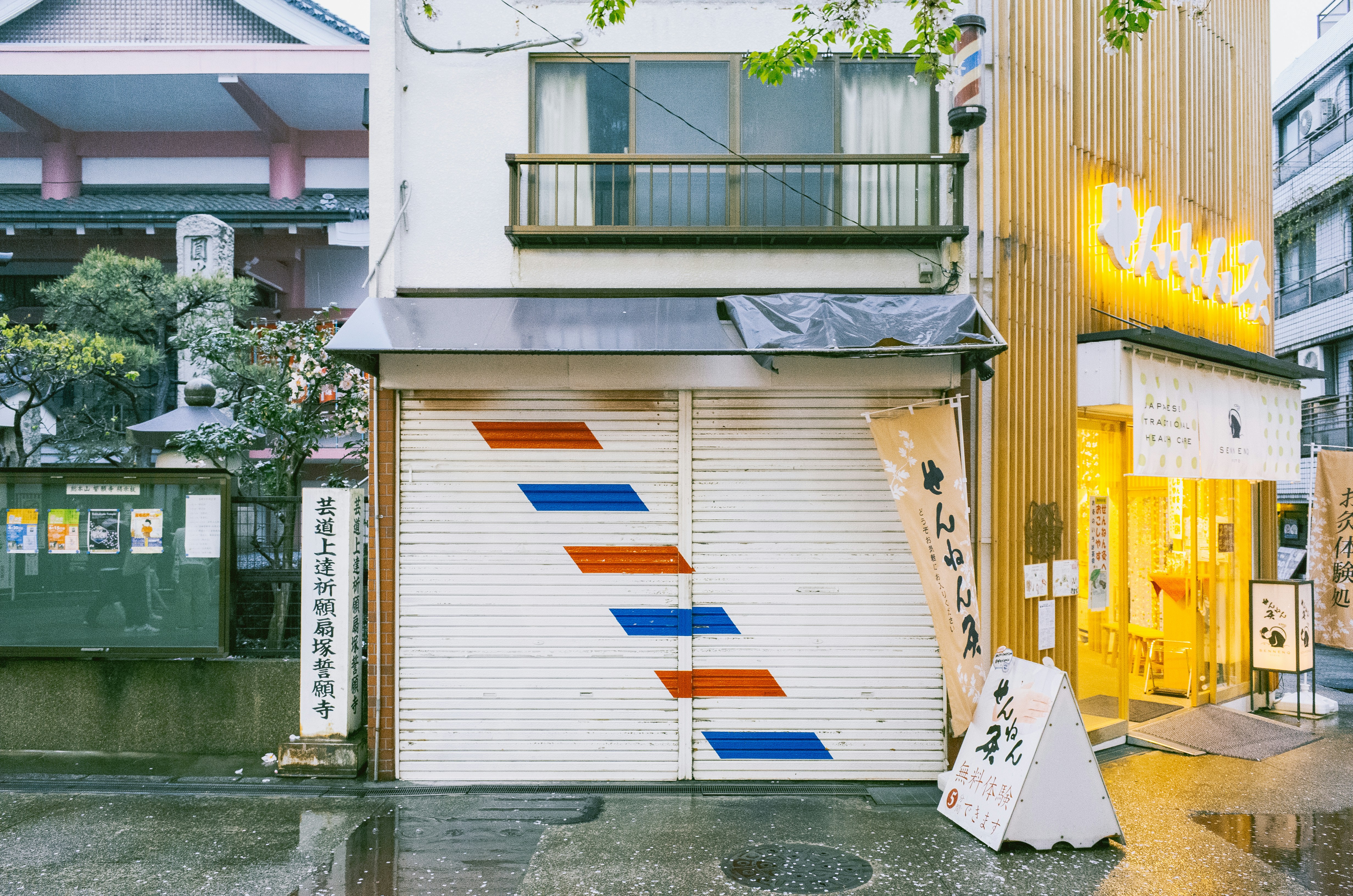 Closed shutter with diagonal stripes recalls a quiet urban palette
