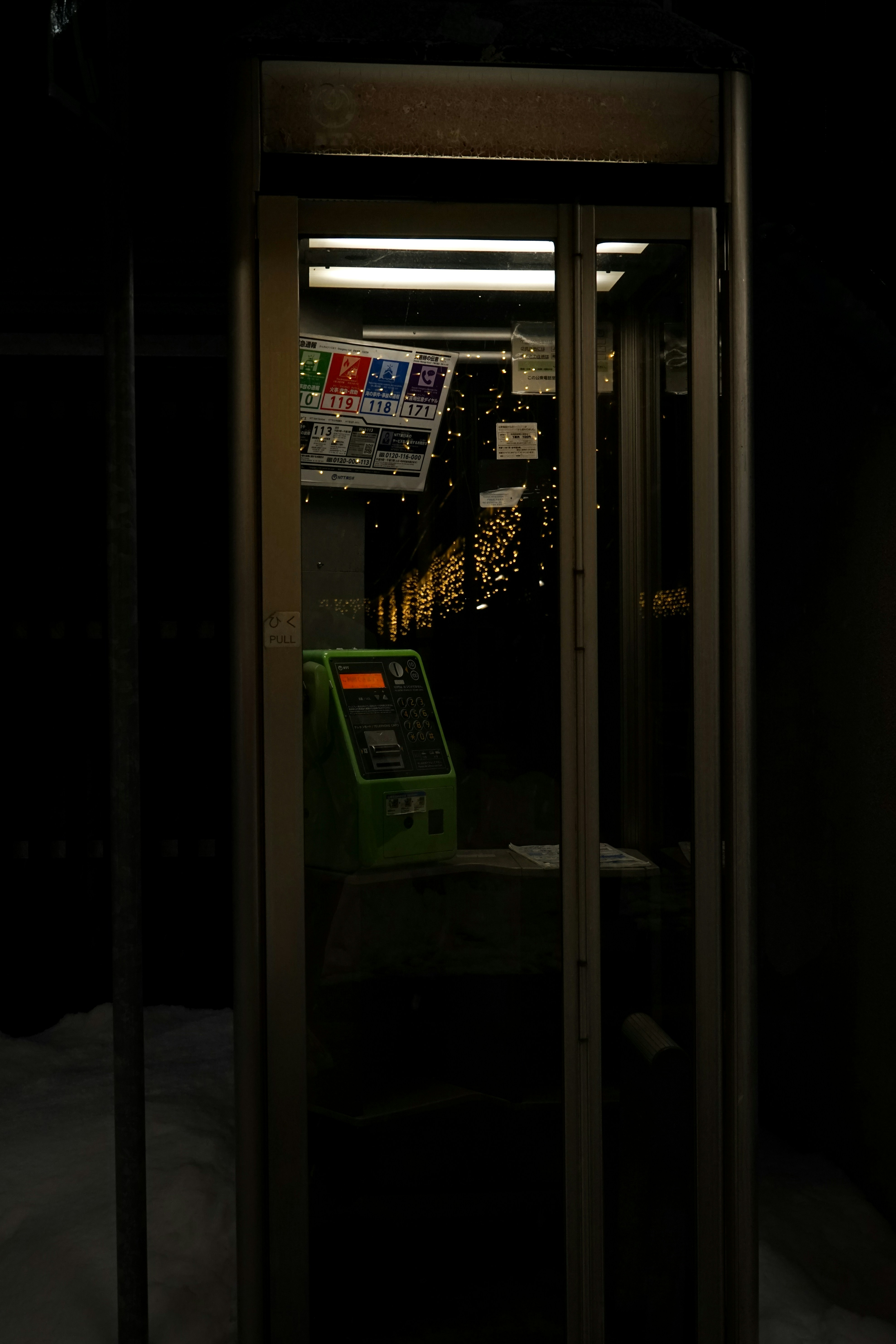 Neon Terminal in the Night: A Quiet Cashier Stand Amid Reflective Glass