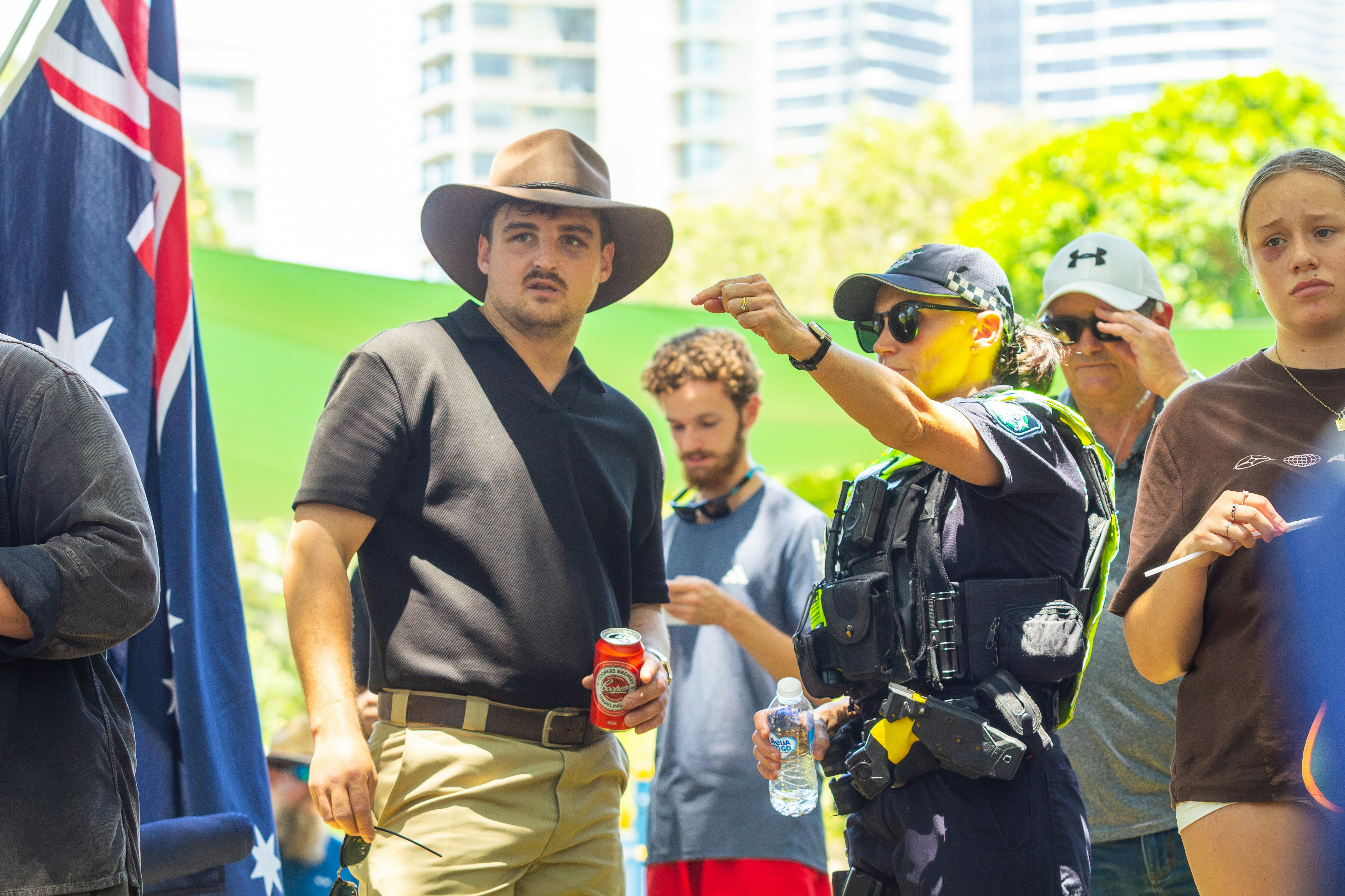 Dusty Confrontation: The Man in the Hat Centered Amid a Group of Onlookers
