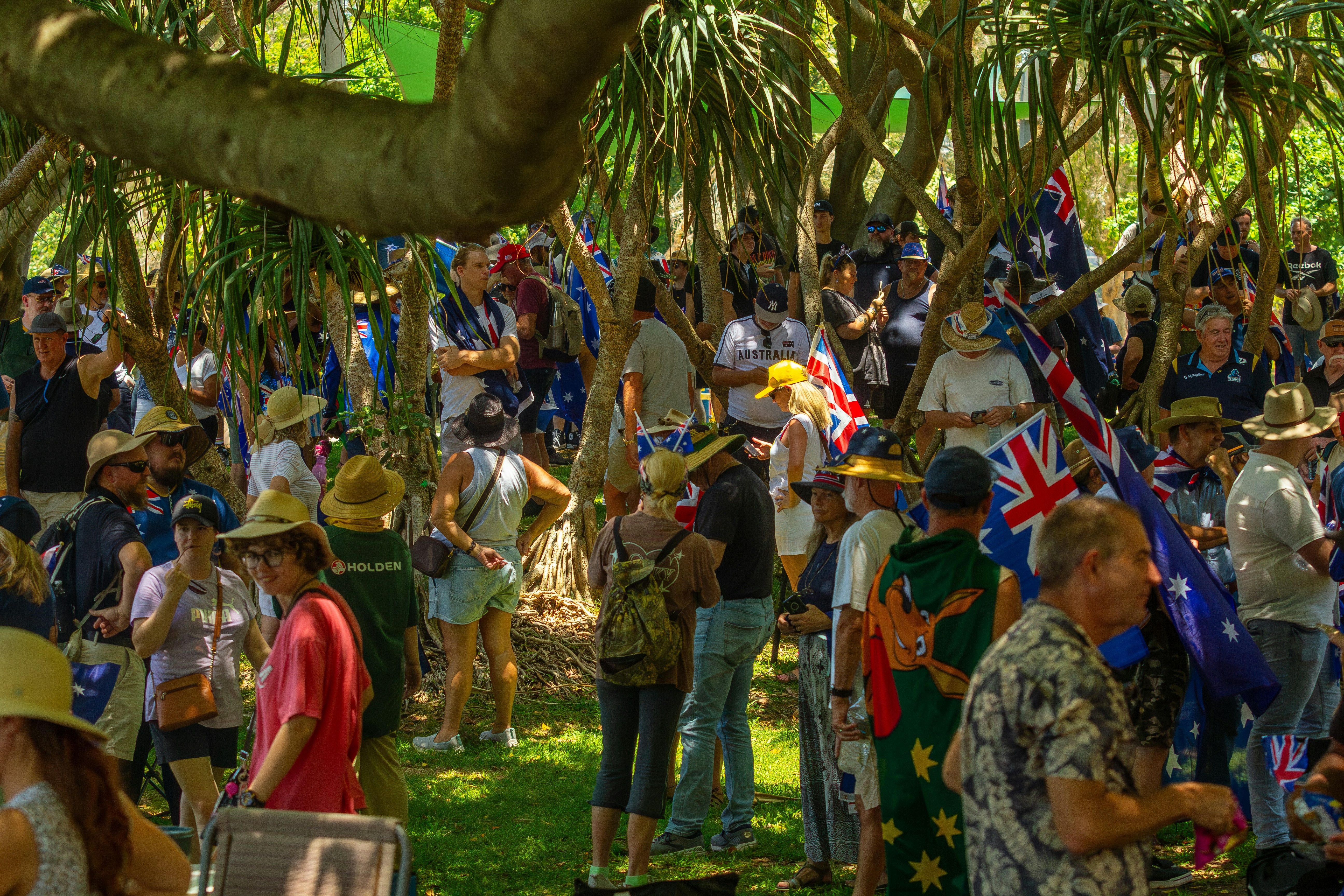 Flags, Straw Hats, and a Crowd: A Summer Gathering Under the Canopy