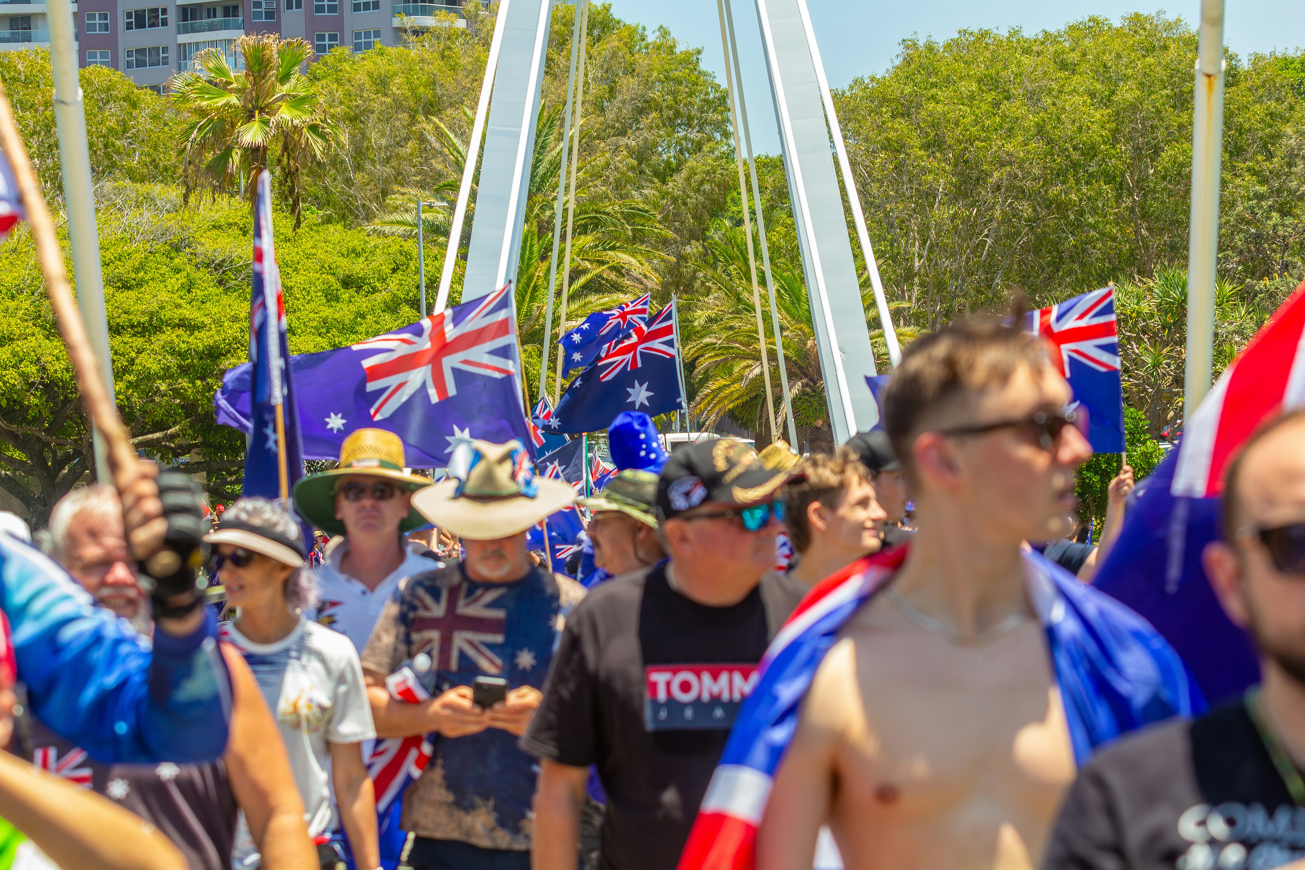 Flags and Faces: A Sunlit City Parade in Motion