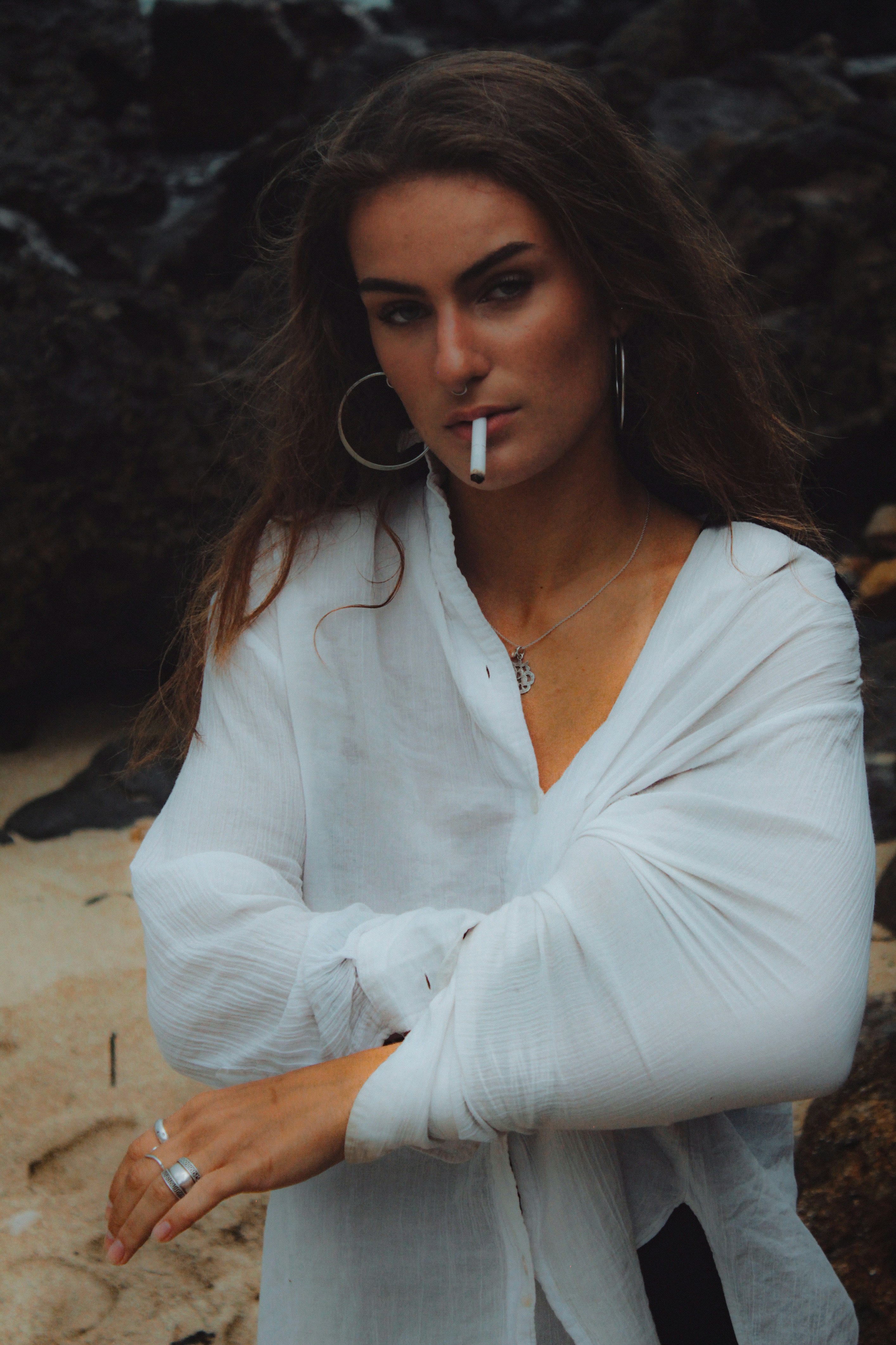 Cigarette-silent gaze on a windswept shoreline