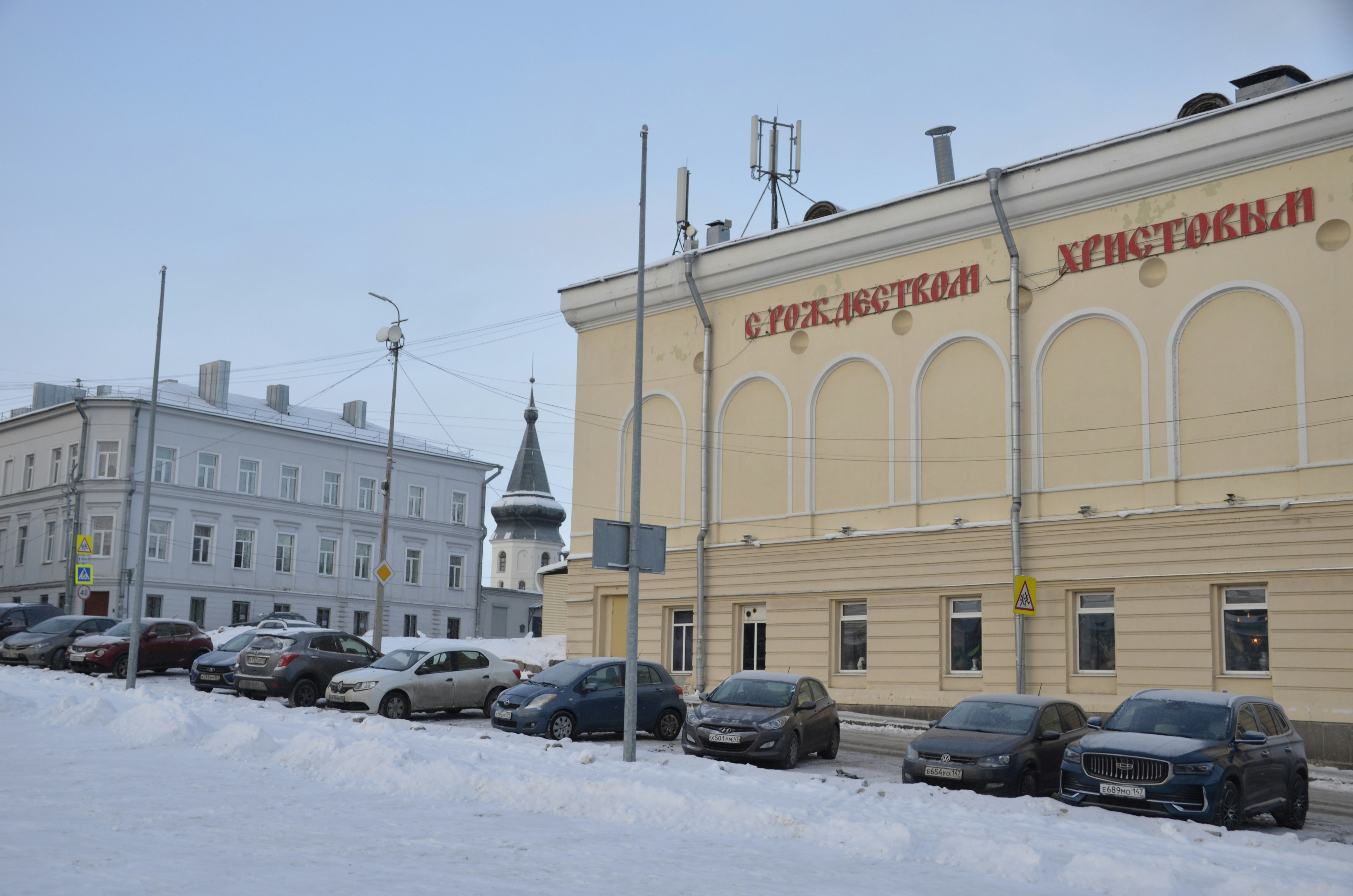 Snowy Streetfront with Classic Architecture and Parked Cars
