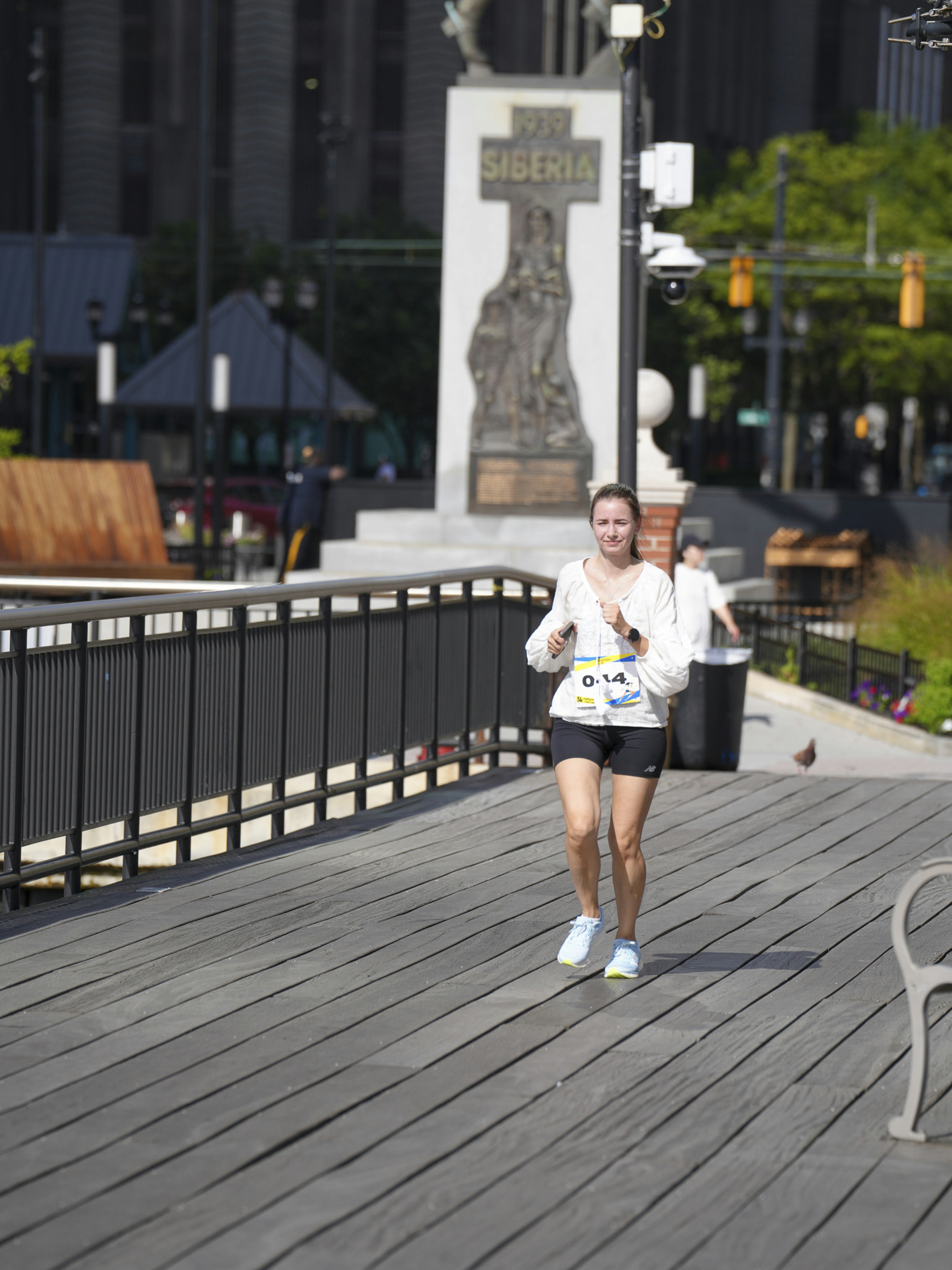 Runner on a Boardwalk Towards the City Monument