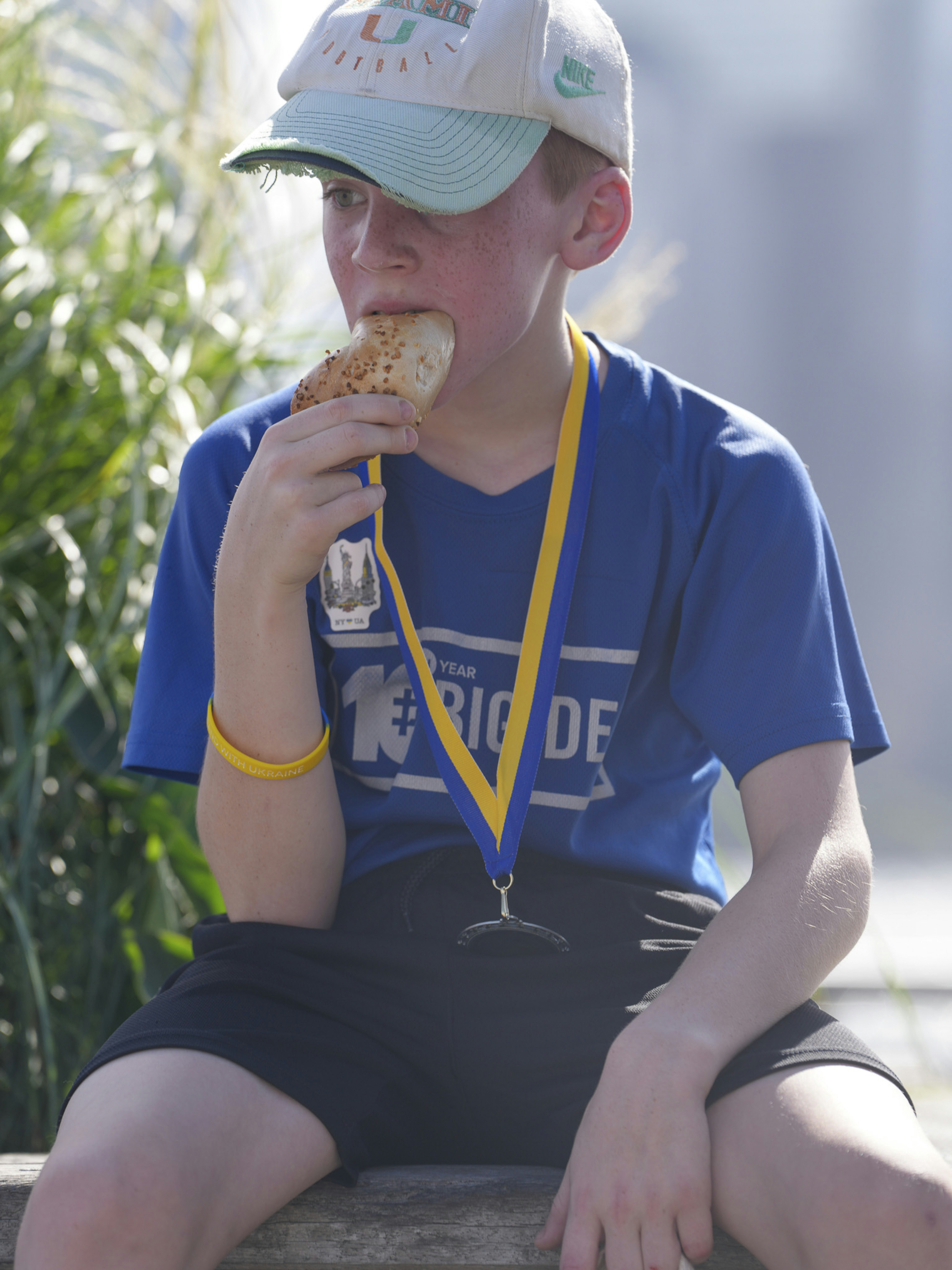 Youth in a Blue Tee Savoring a Moment: A Casual Snack Break
