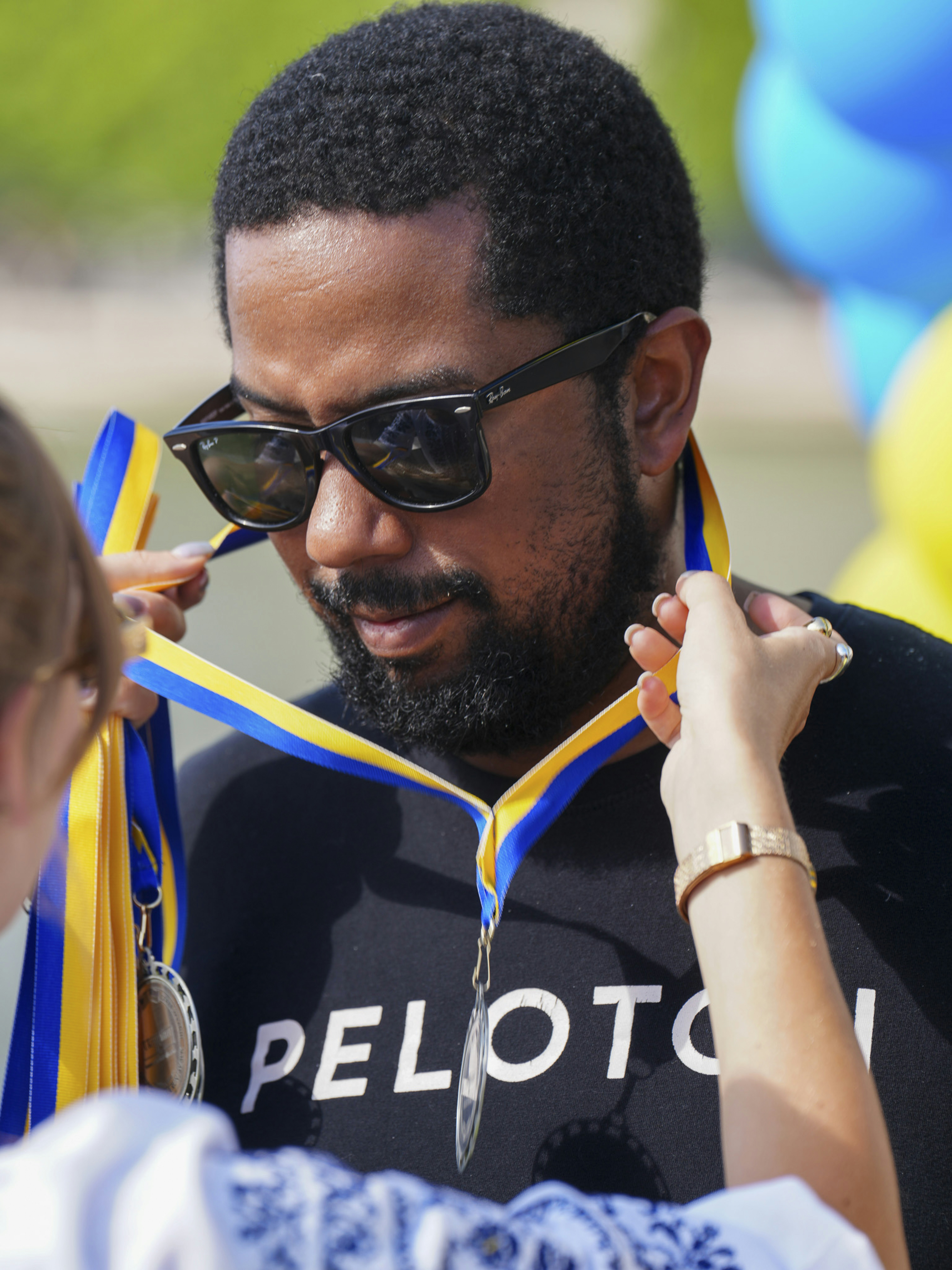 Sunglasses, Ribbon, and a Moment of Medal Ceremony