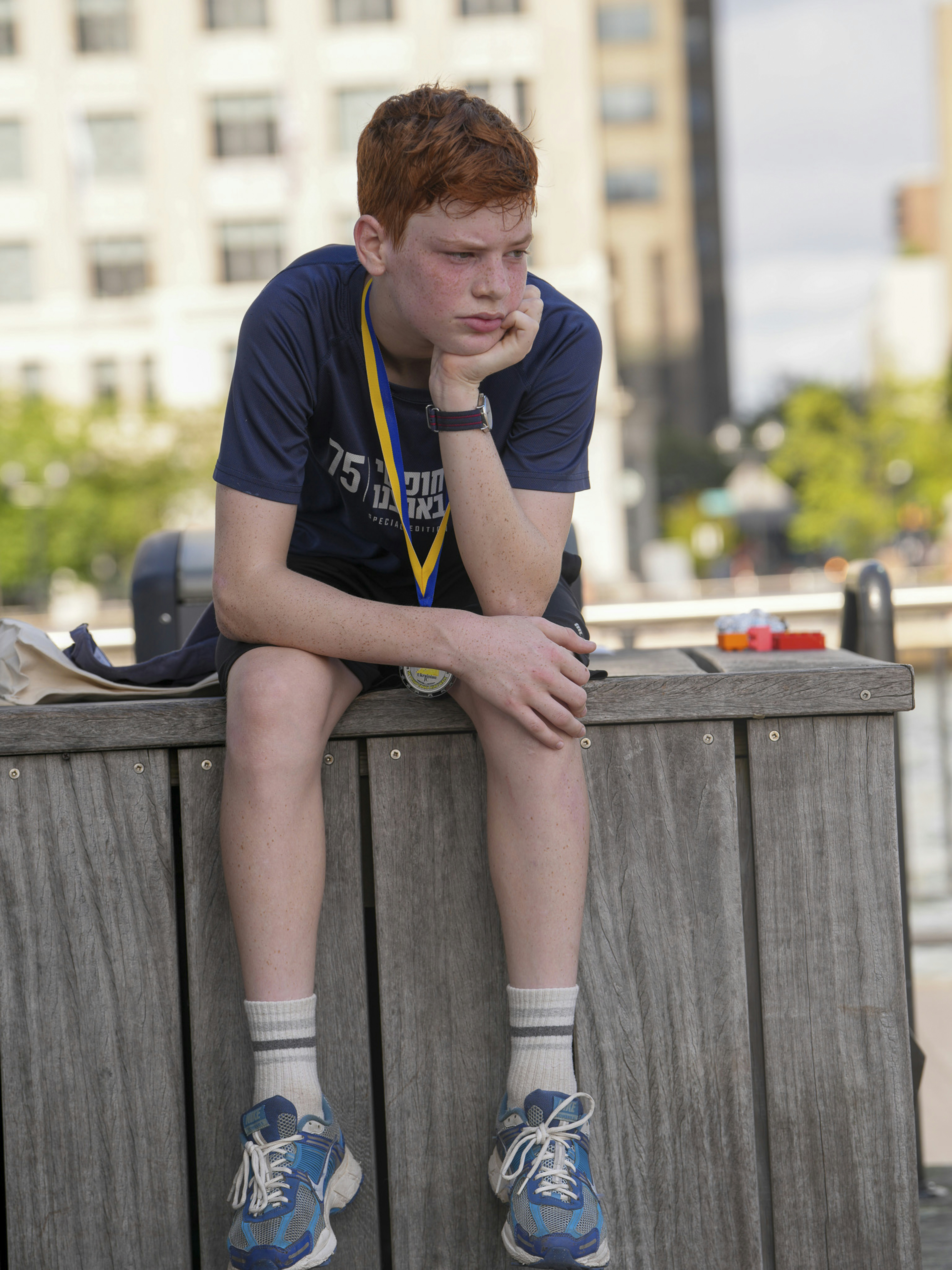 Contemplative Moment: A Teen Astride the City’s Edge