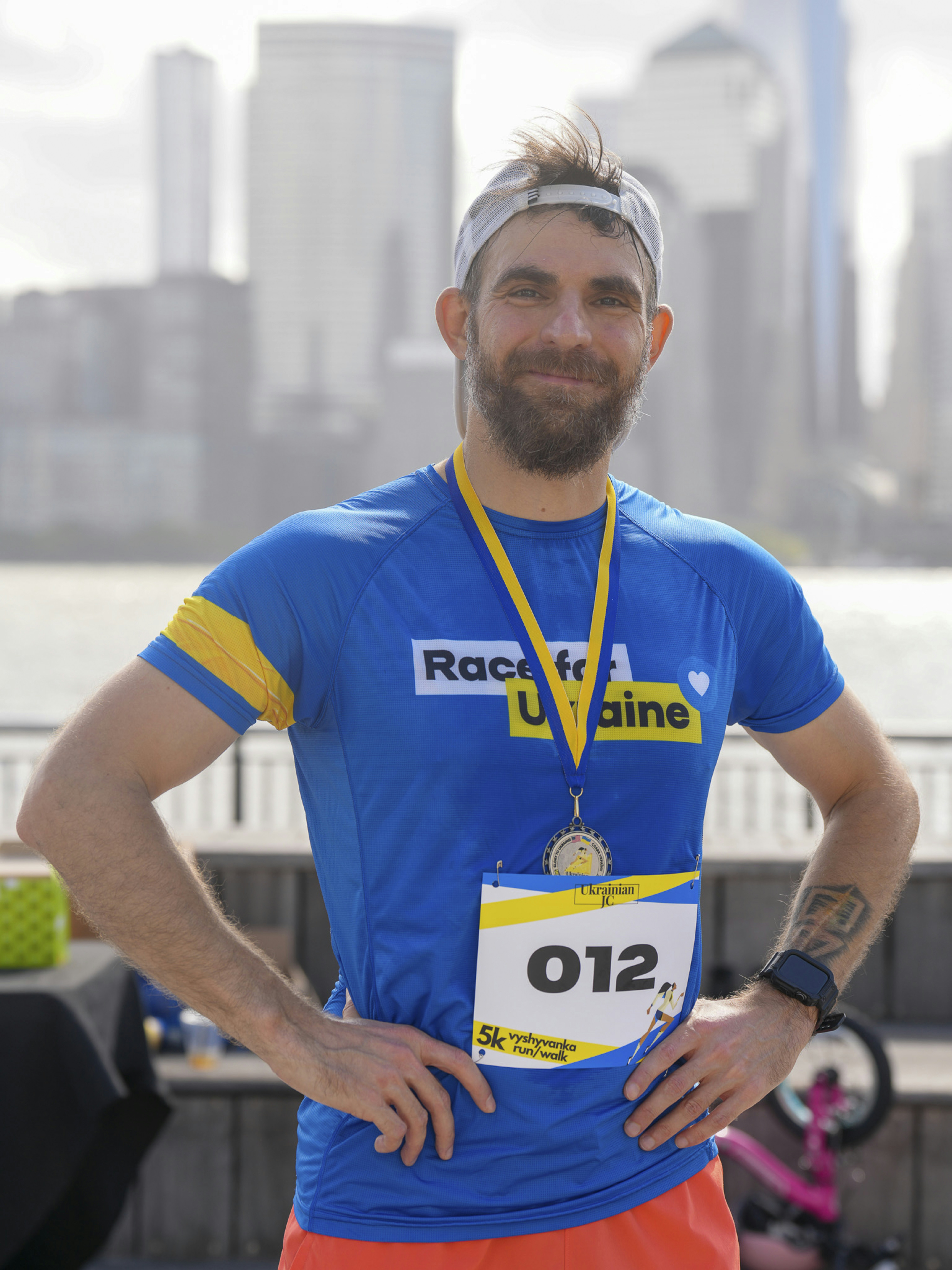 Medal-Ready in Blue: A Runner's Pride by the Waterfront