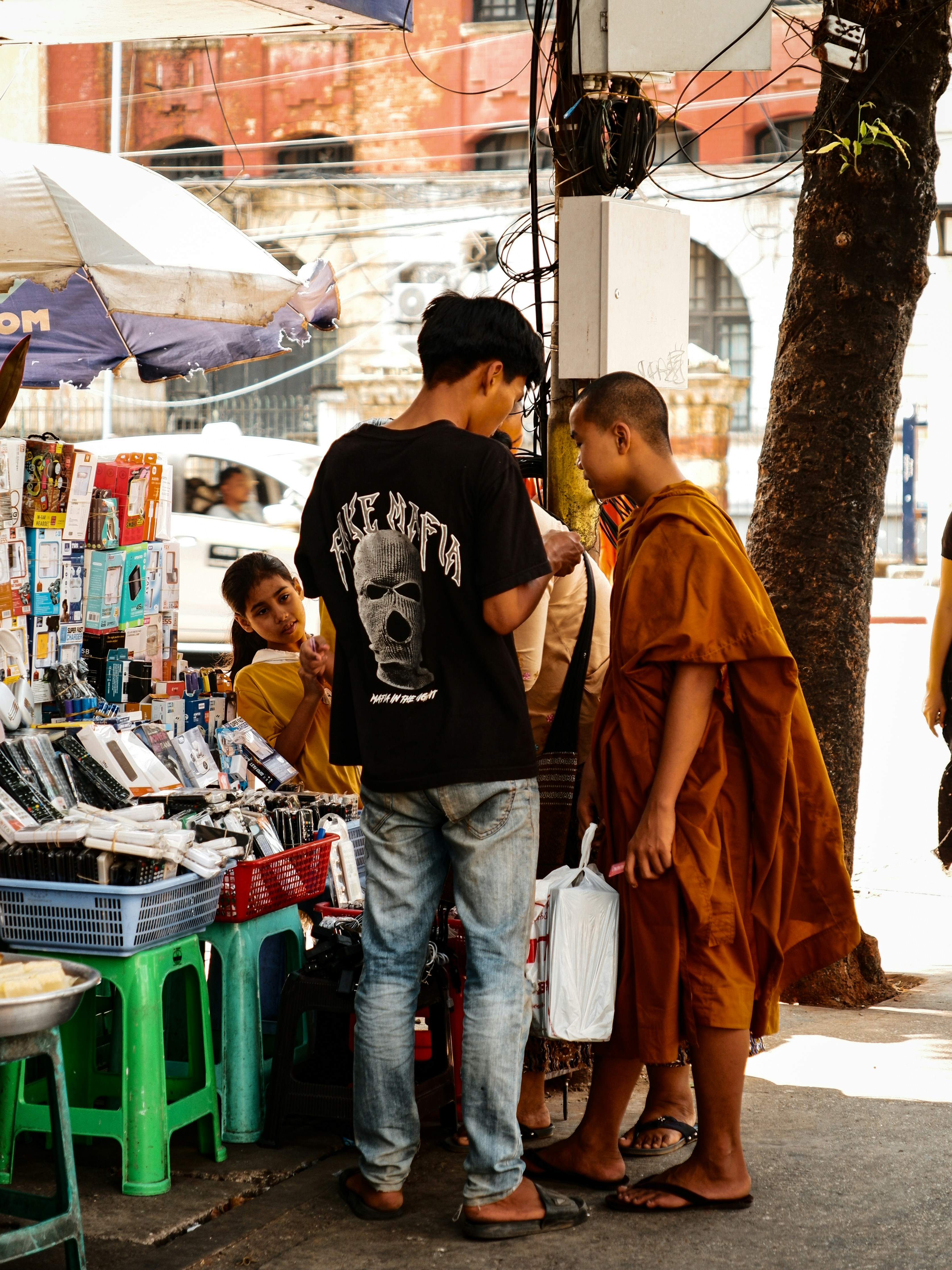 A monk and a young man at a street market