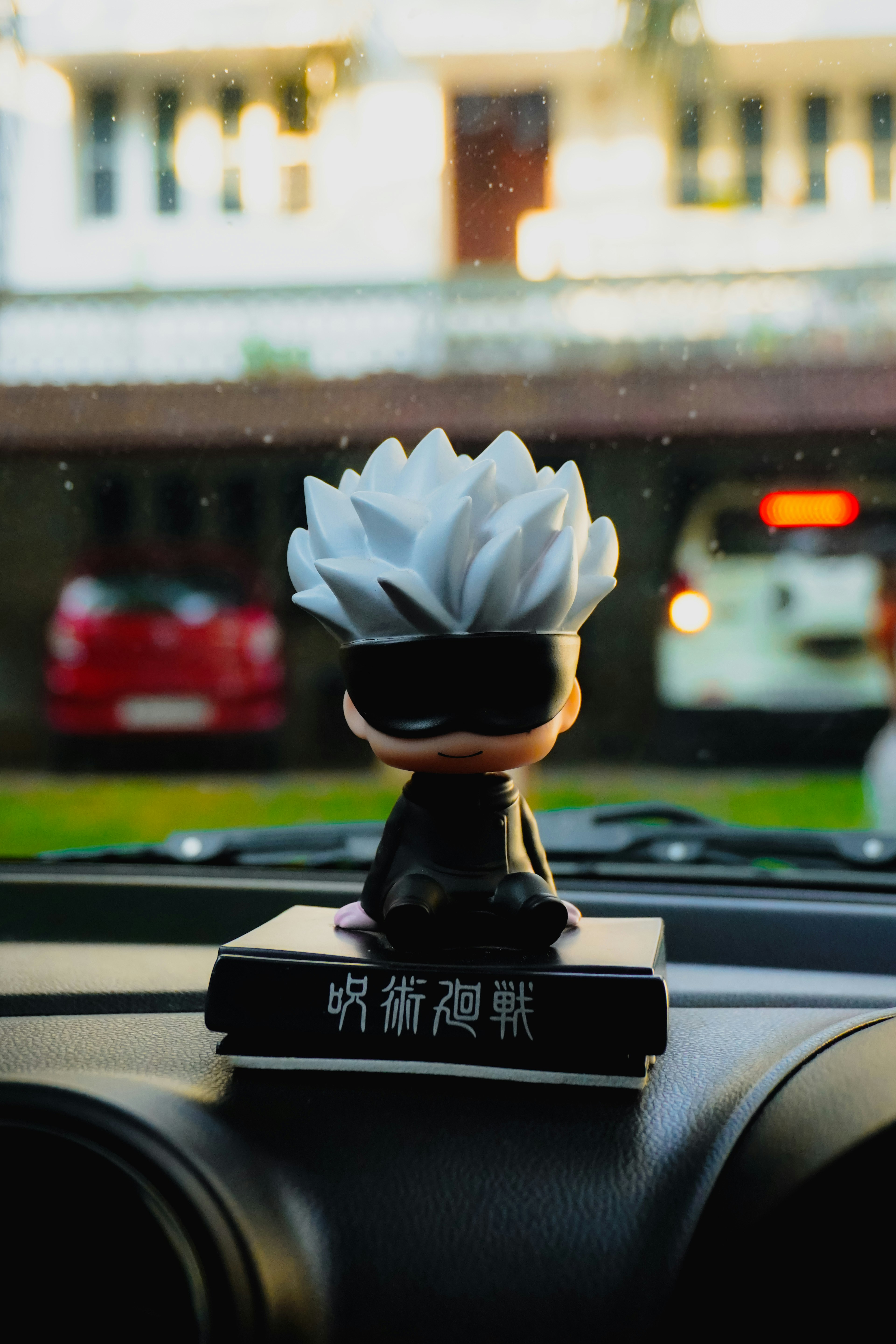 Sung Guardian: A Funko on the Dashboard Beckoning the Daylight