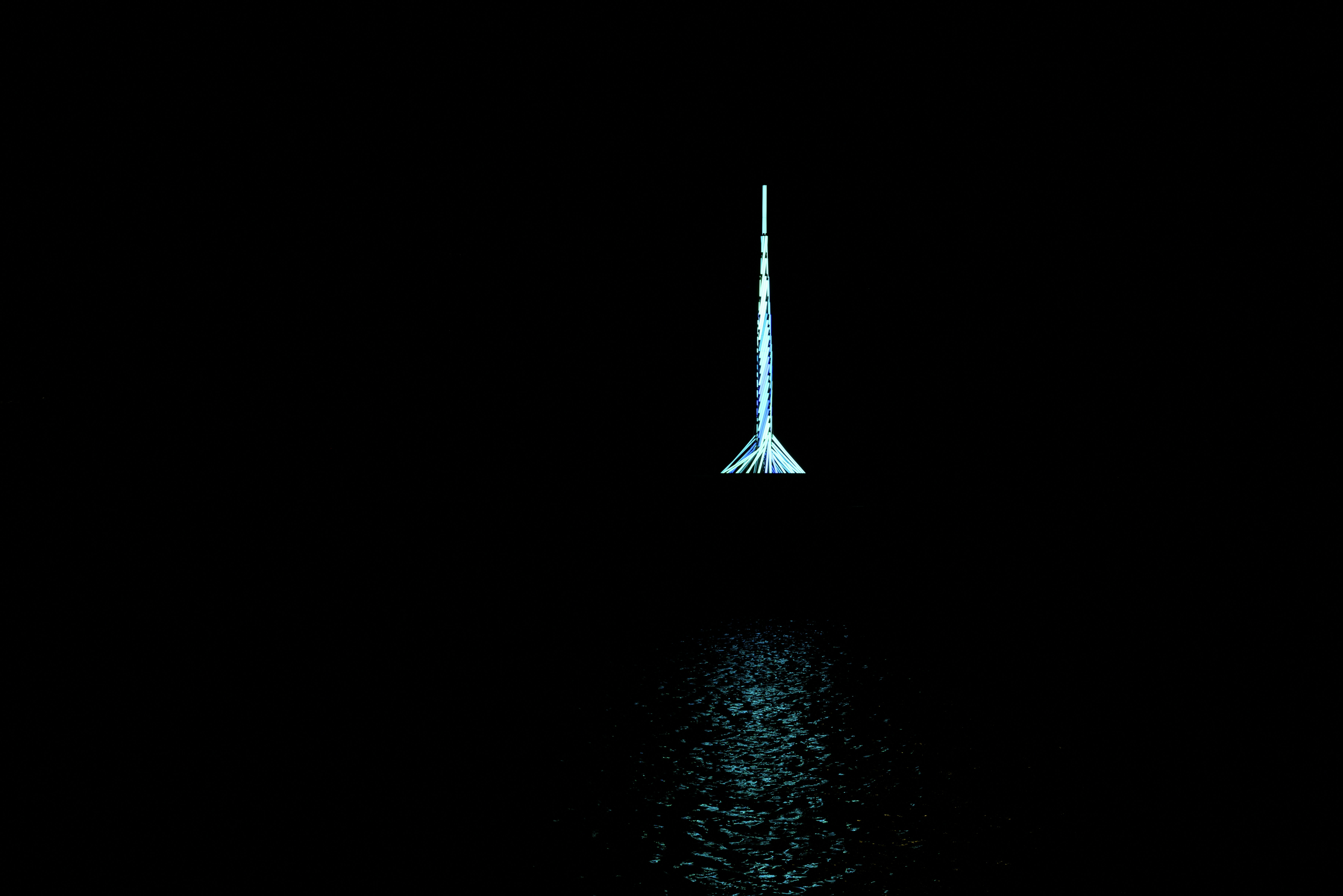 Luminous beacon over midnight water